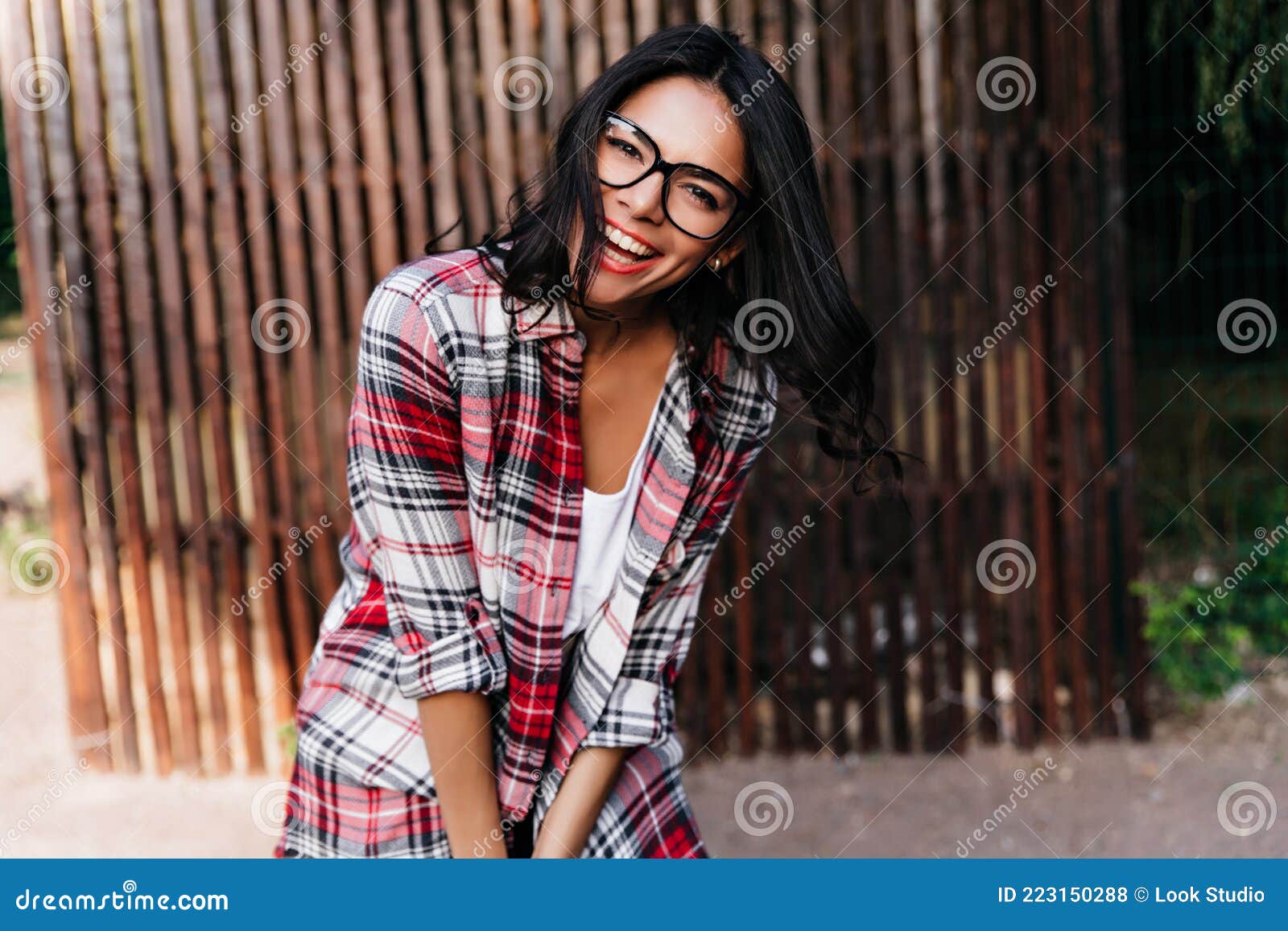 Spectacular Dark Haired Woman Posing With Interested Face Expression On