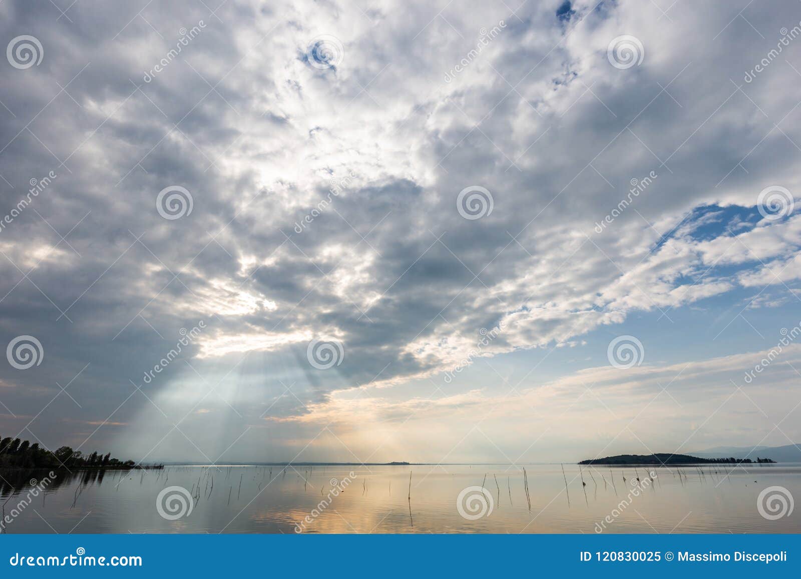 Spectacular View of a Lake, with Clouds, Sky and Sun Rays Reflecting on ...