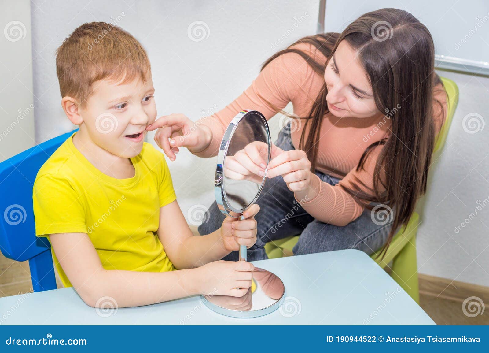 Speech Language Pathologist Helping Child Learn Letters And Overcome ...