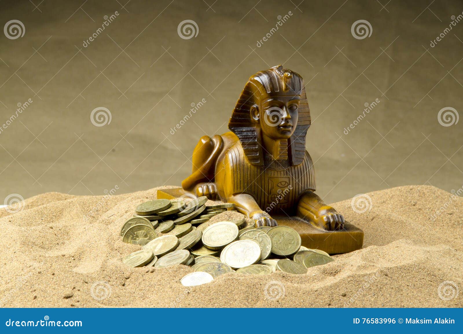 Sphinx and Coins in the Sand Stock Photo - Image of figurine, table ...