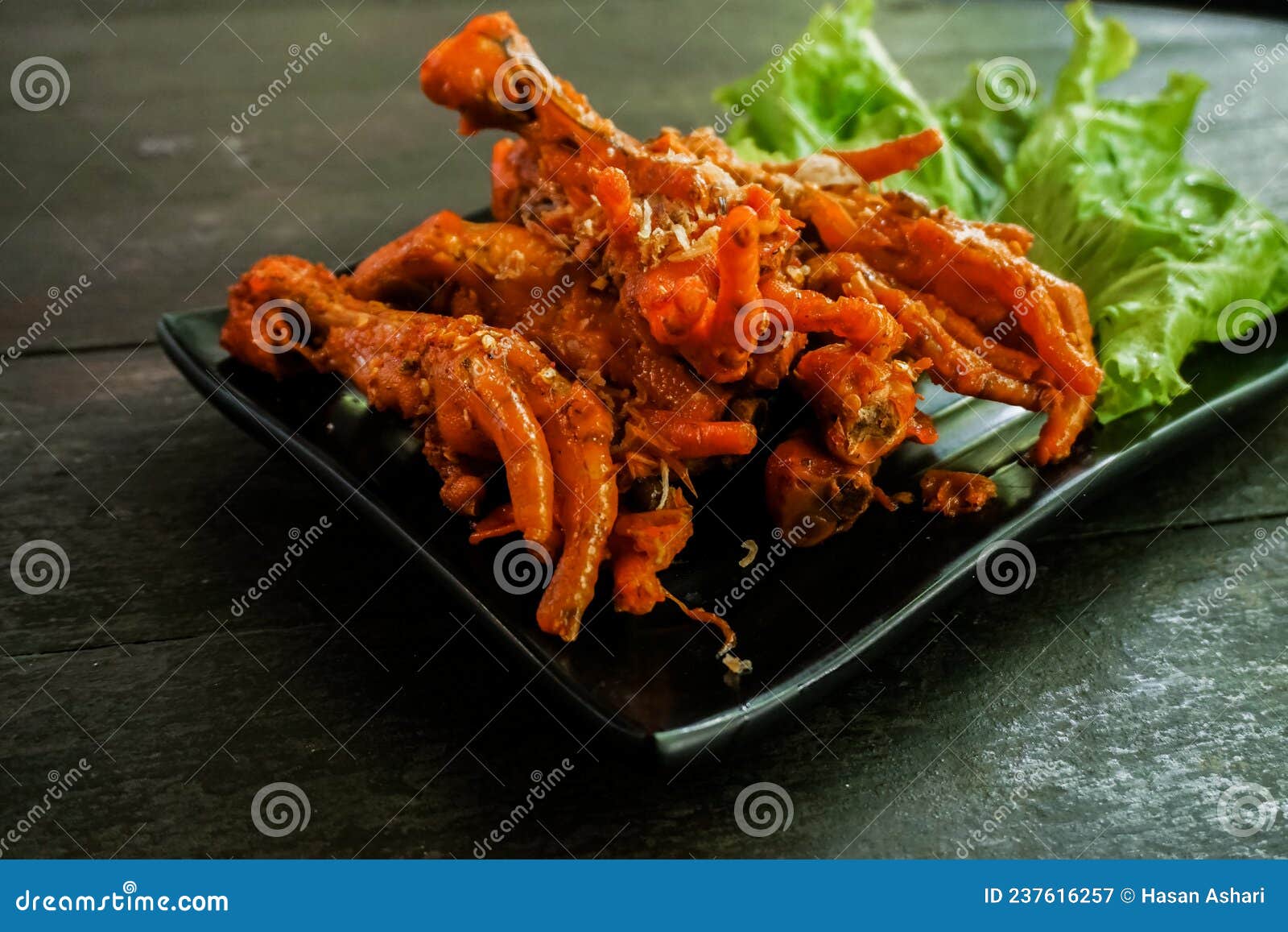 Spicy Chicken Feet on a Black Rectangular Plate on the Dining Table ...