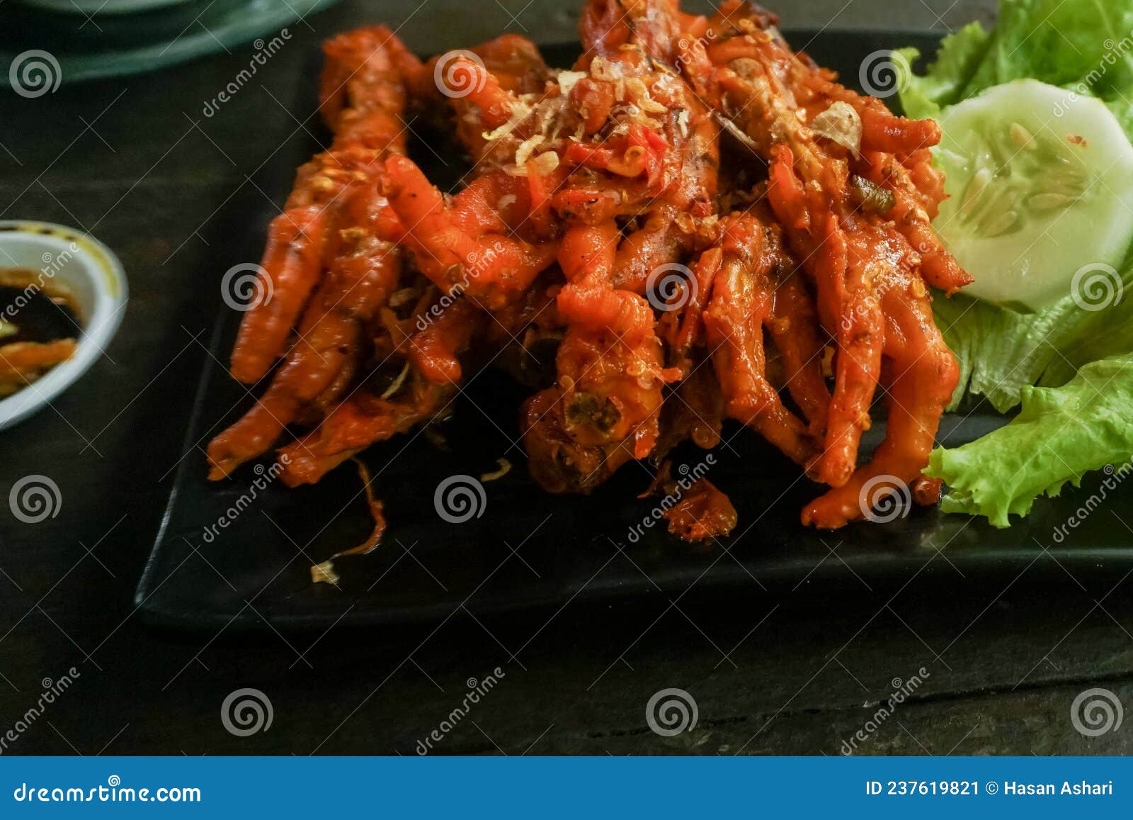 Spicy Chicken Feet on a Black Rectangular Plate on the Dining Table ...