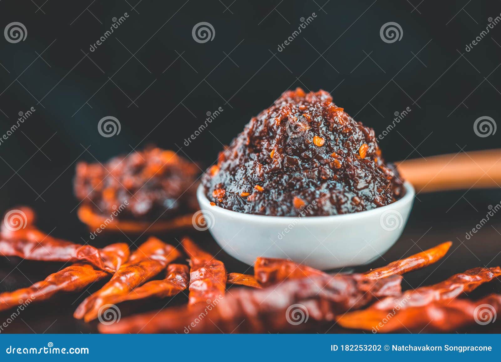 Spicy Chili Paste in White Ceramic Container on Dark Background Stock ...