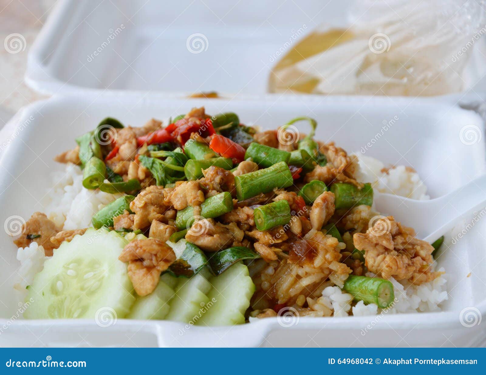 Spicy Stir Fried Chicken with Basil Leaf on Rice in Foam Box for Take ...
