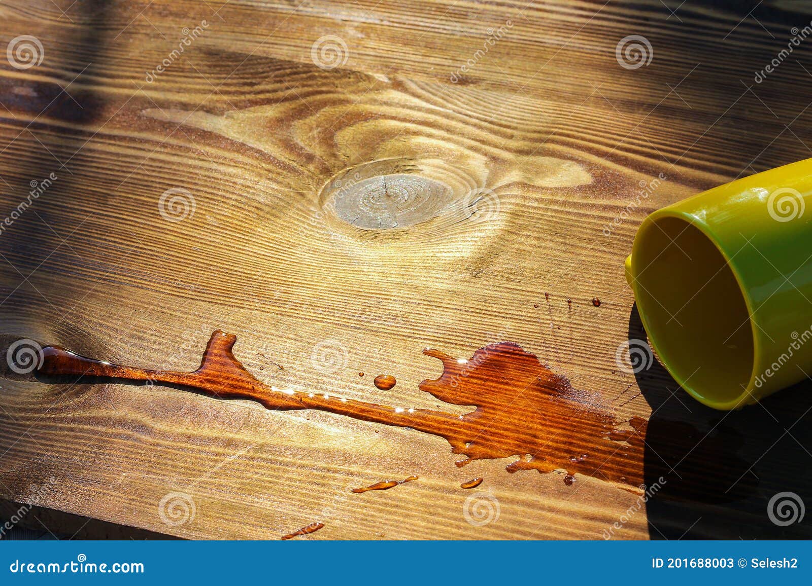 Spilled Drink on the Table. an Overturned Mug of Tea on a Wooden Table ...