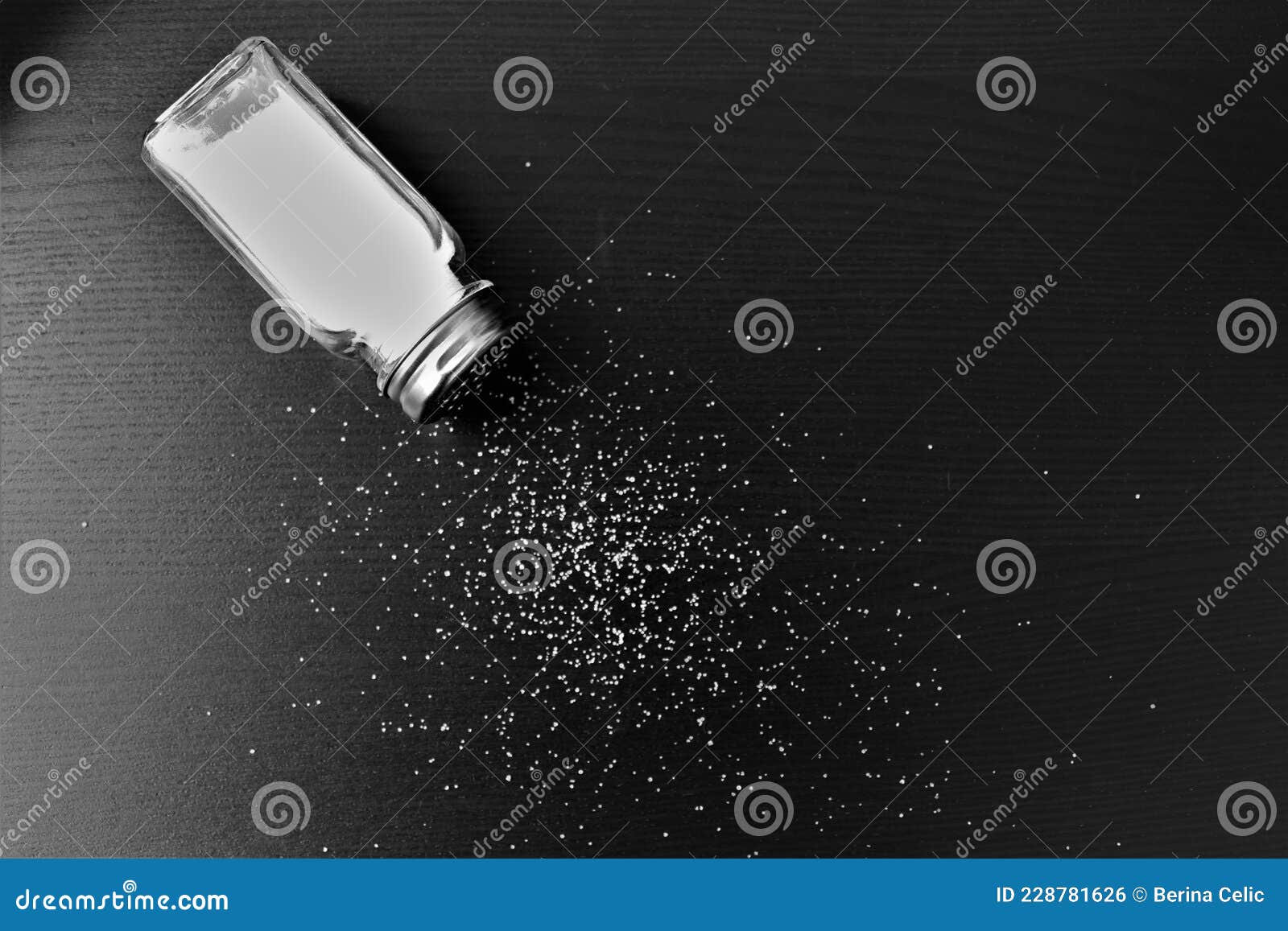 Spilled Salt in a Glass Salt Shaker on a Black Table Stock Photo ...