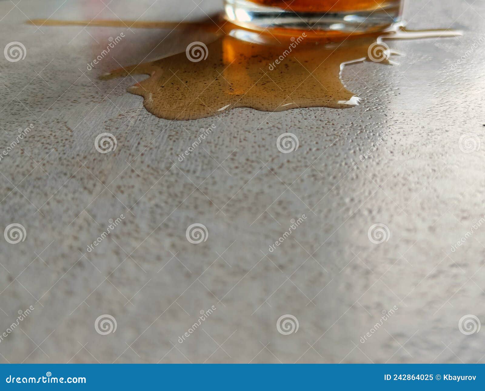 Spilled Tea Under a Transparent Cup on a White Table Stock Image ...