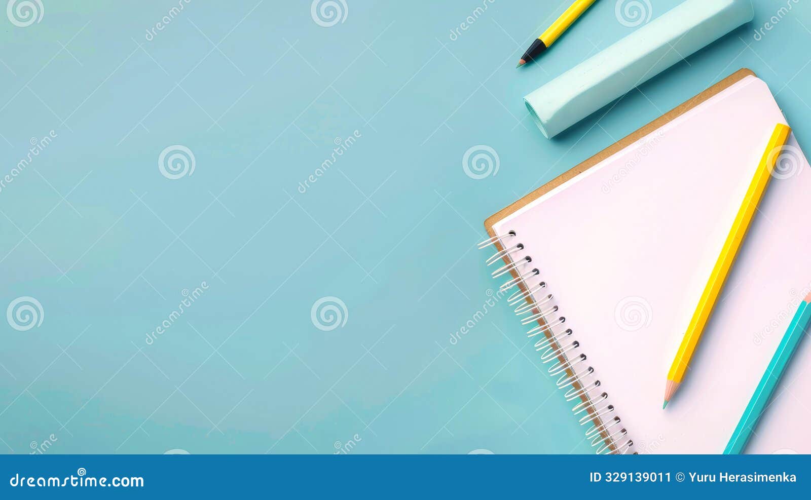 A Spiral-bound Notebook, a Pencil, and a Ruler Sit on a Pastel Blue ...