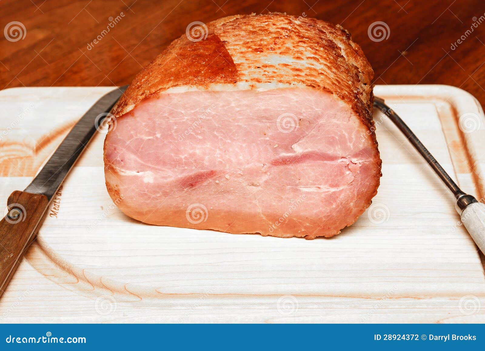 Spiral Sliced Ham on Carving Board with Knife and Fork Stock Photo ...
