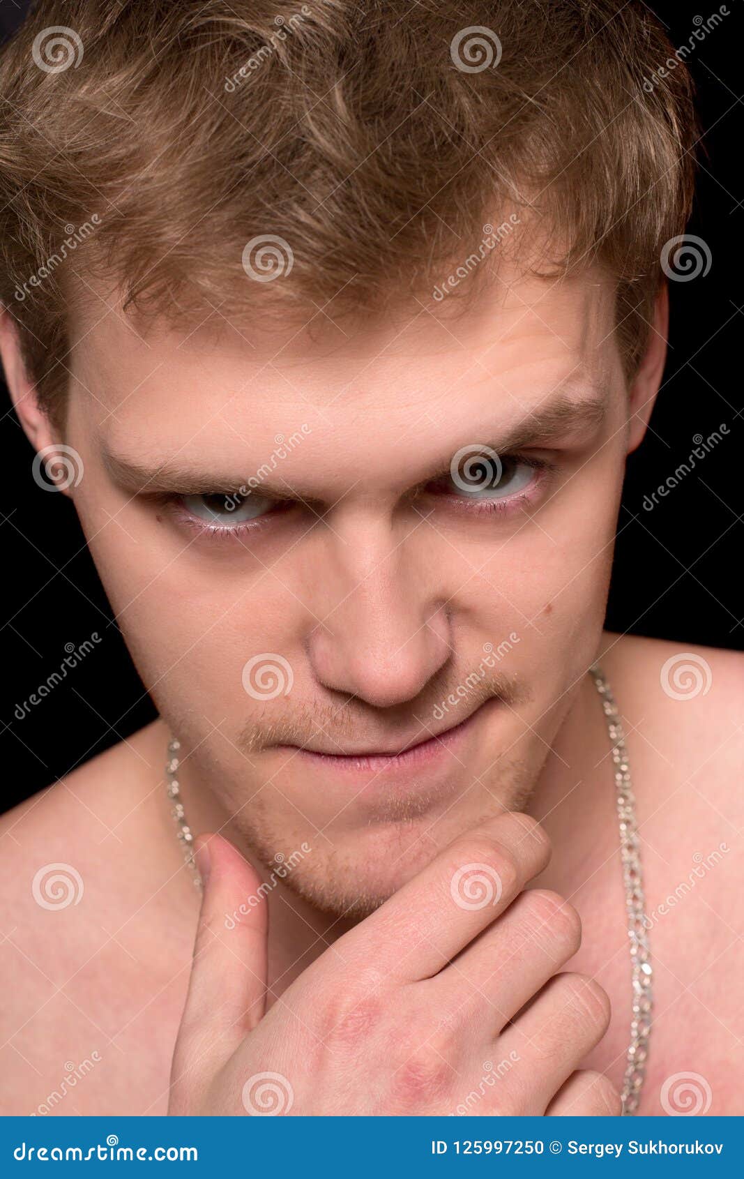 Spiteful young man stock photo. Image of emotion, grin - 125997250