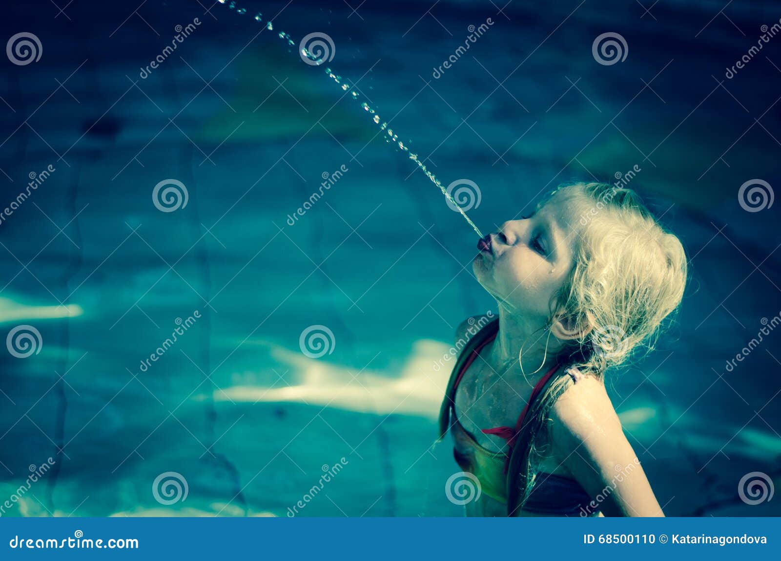 Spitting water in the pool stock photo. Image of girl - 68500110