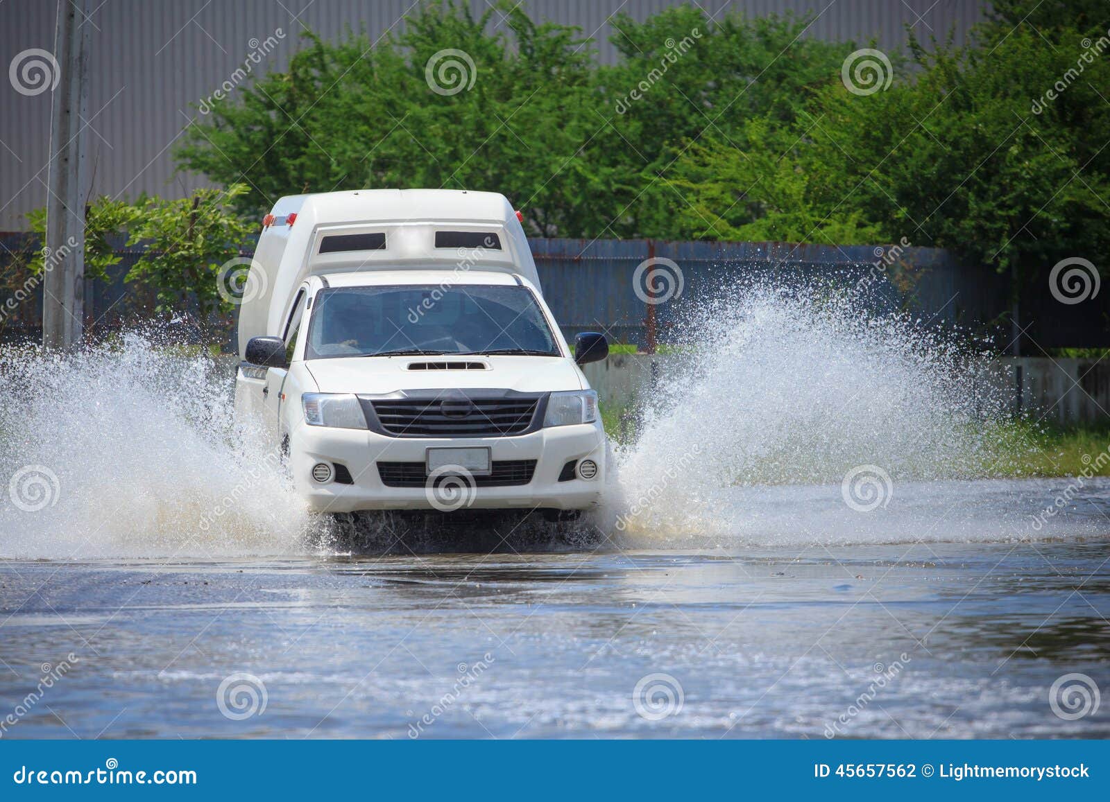 Mud Splash By A Car As It Goes Through Flood Water Stock Photo ...