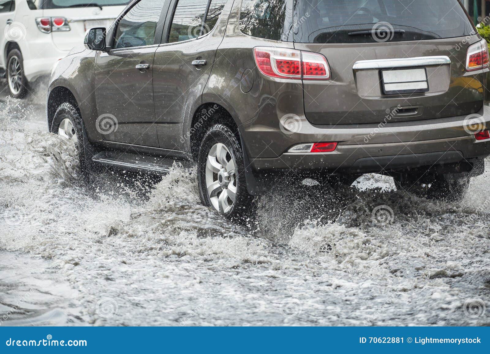Mud Splash By A Car As It Goes Through Flood Water Stock Photo ...
