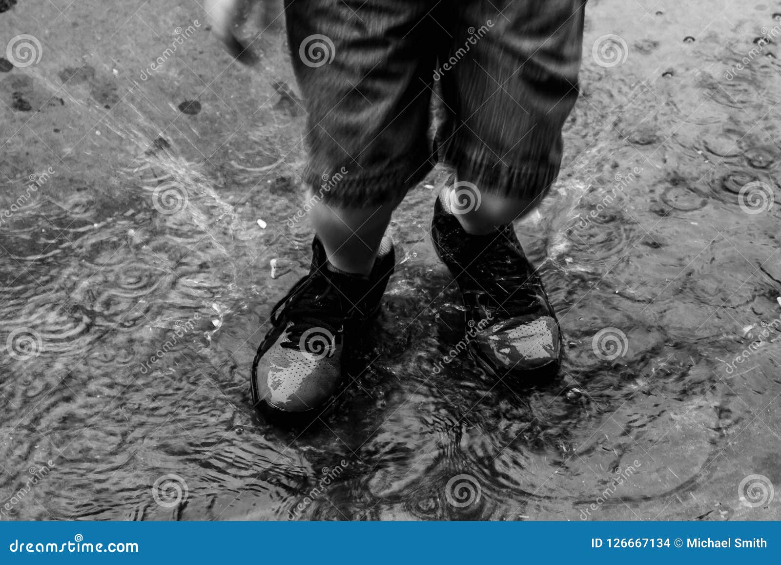Splash from a Child Jumping in a Rain Puddle Stock Photo - Image of ...
