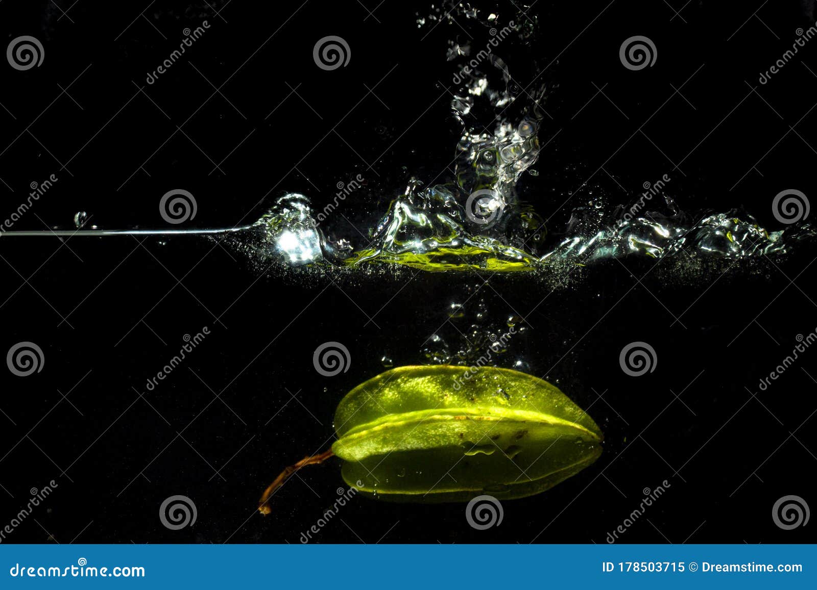 Splash of Fresh Starfruit Water on a Black Background Stock Image ...