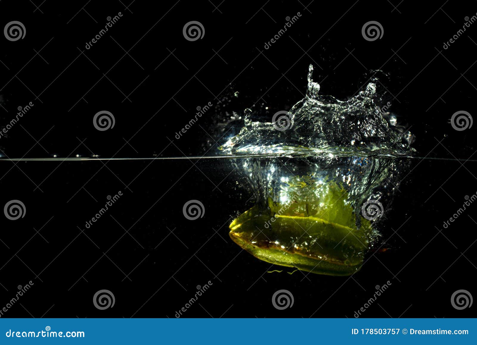 Splash of Fresh Starfruit Water on a Black Background Stock Image ...