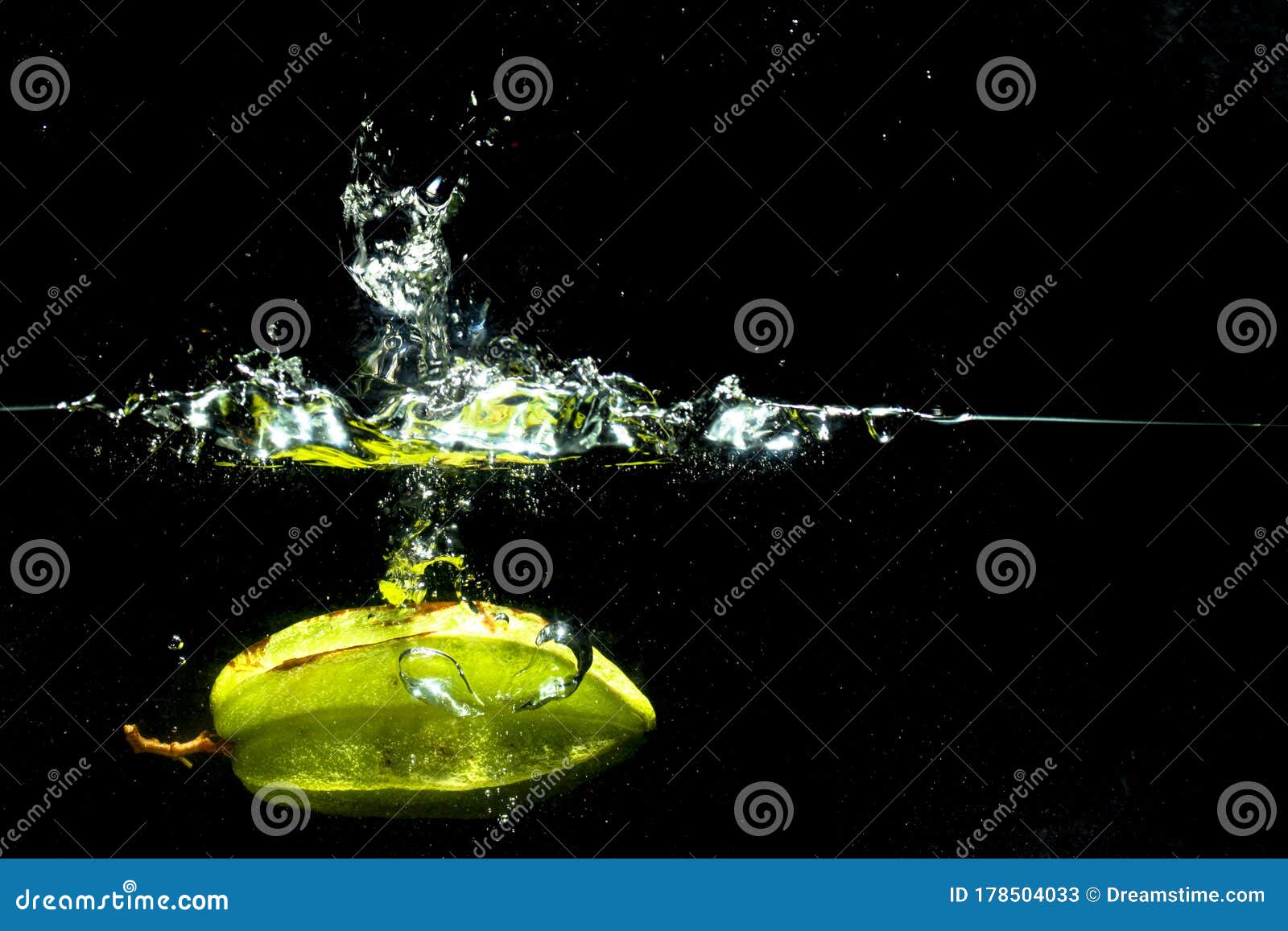 Splash of Fresh Starfruit Water on a Black Background Stock Image ...