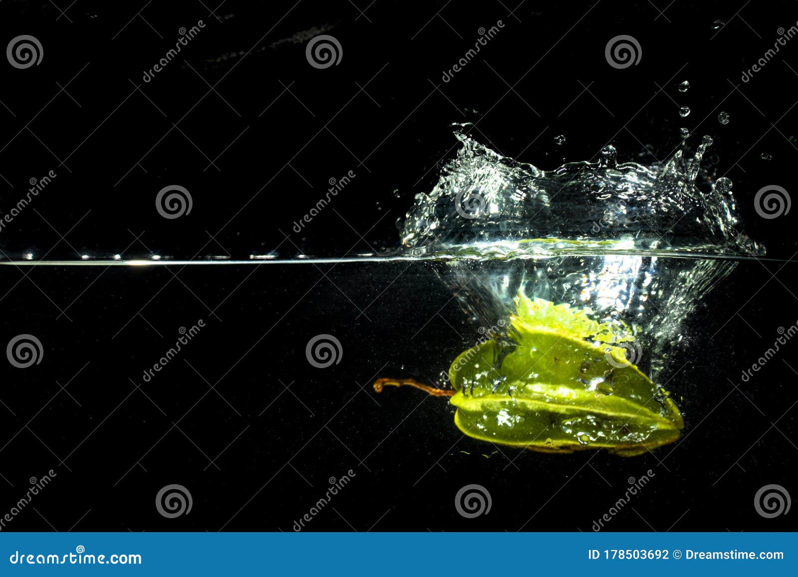 Splash of Fresh Starfruit Water on a Black Background Stock Photo ...