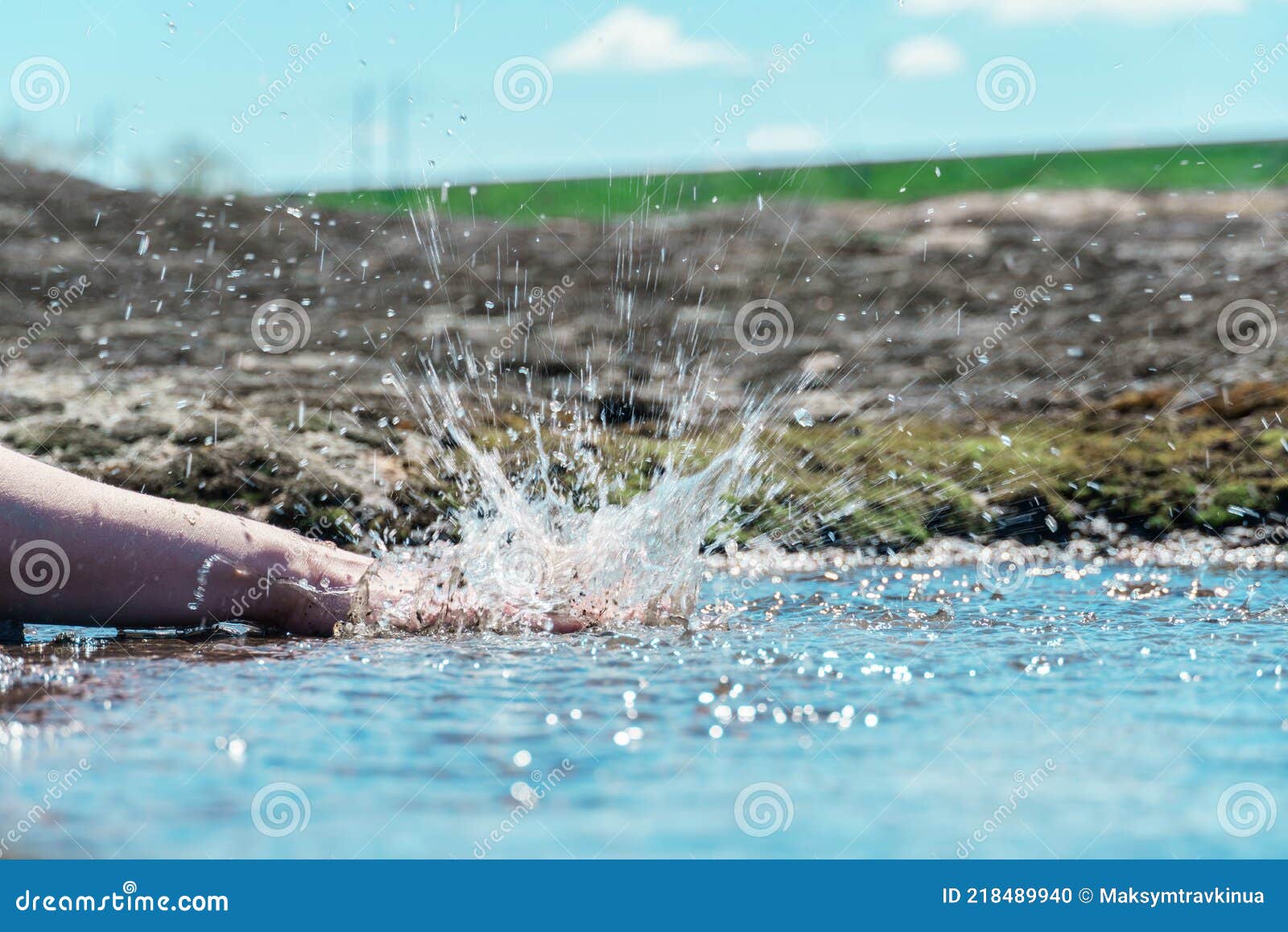 Splash Hands in a Puddle. a Female Hand Clapping in a Puddle Stock ...