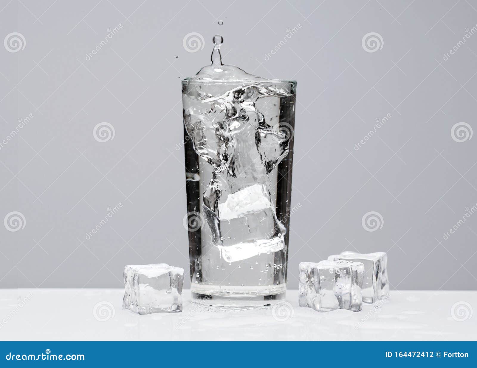 Splash of Ice Cube Falling into Water Stock Photo - Image of single ...