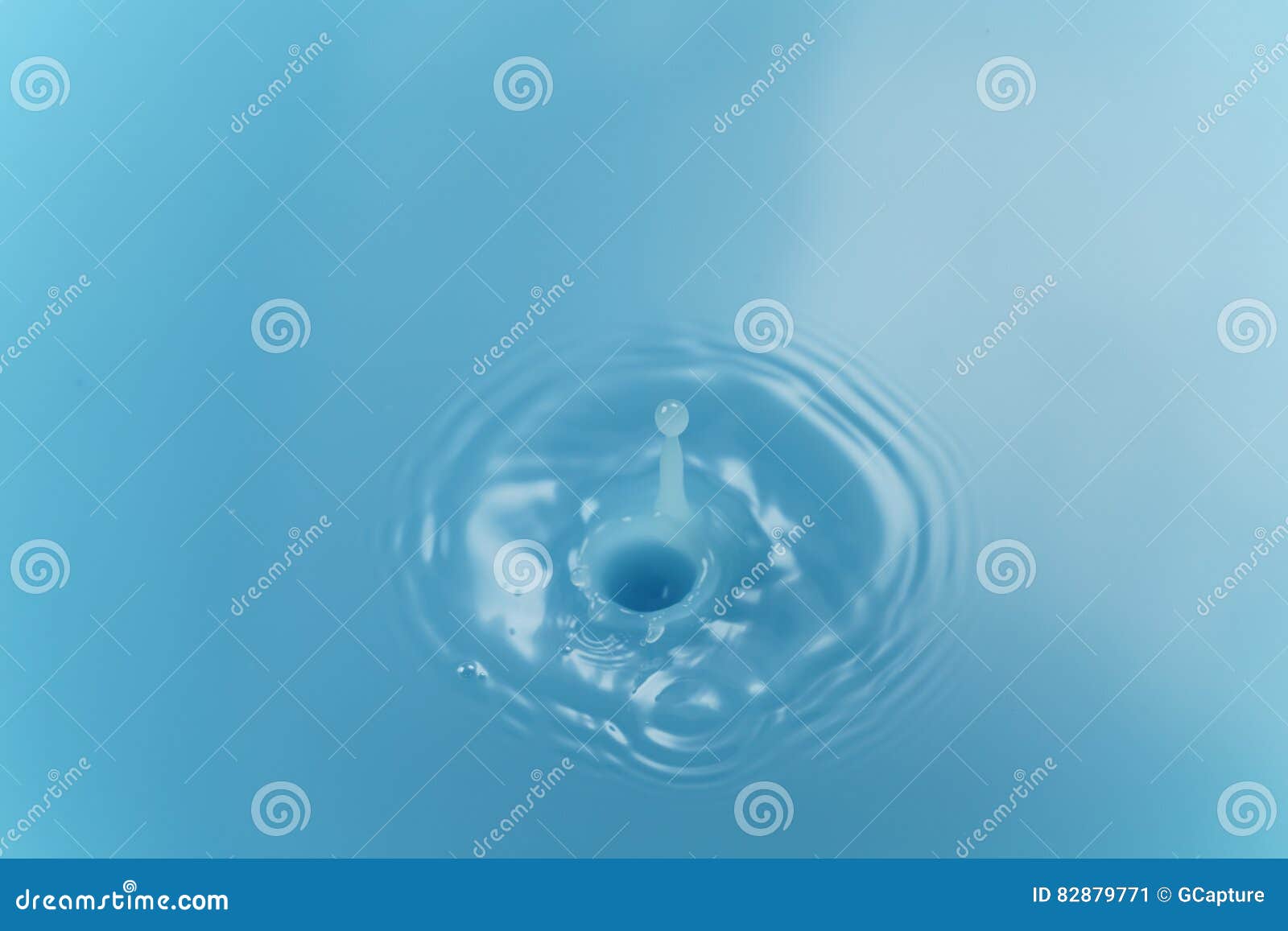 Splash on Light Blue Water Surface from Above Stock Image - Image of ...