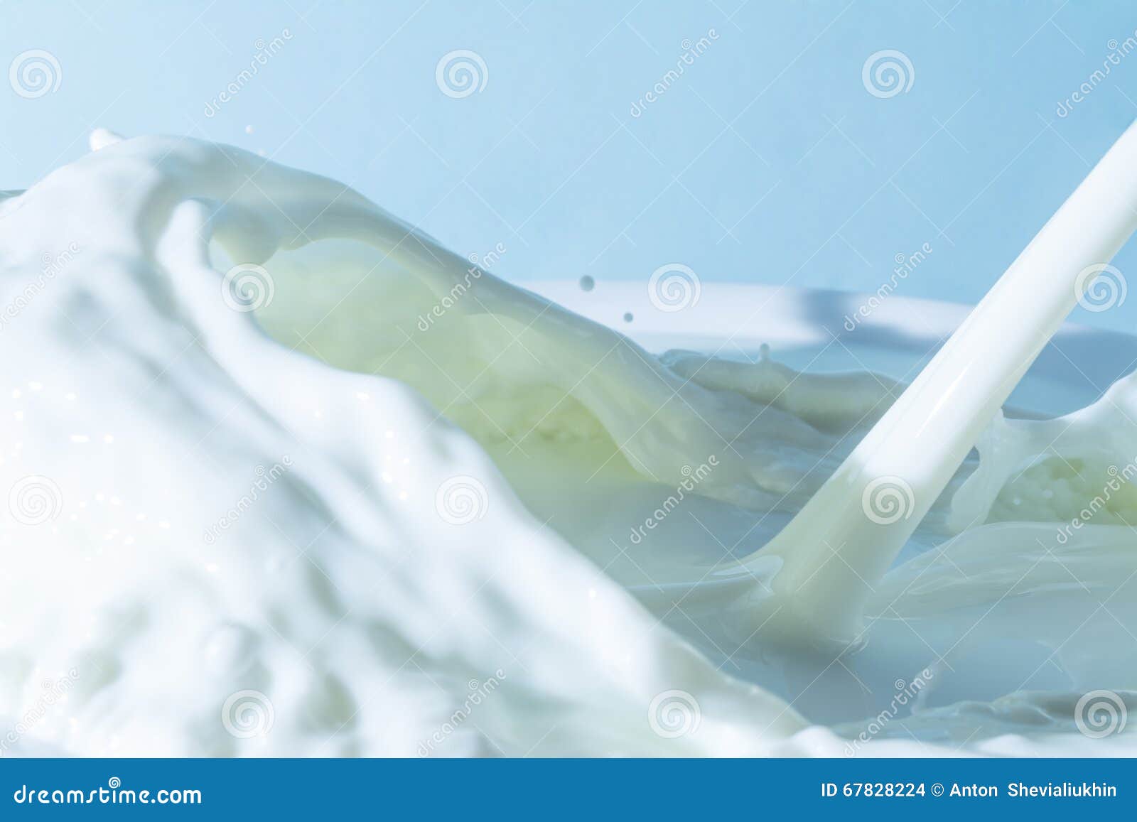Splash Of Milk, Pouring Jet Stream Of Milk, Blue Background Stock Photo ...
