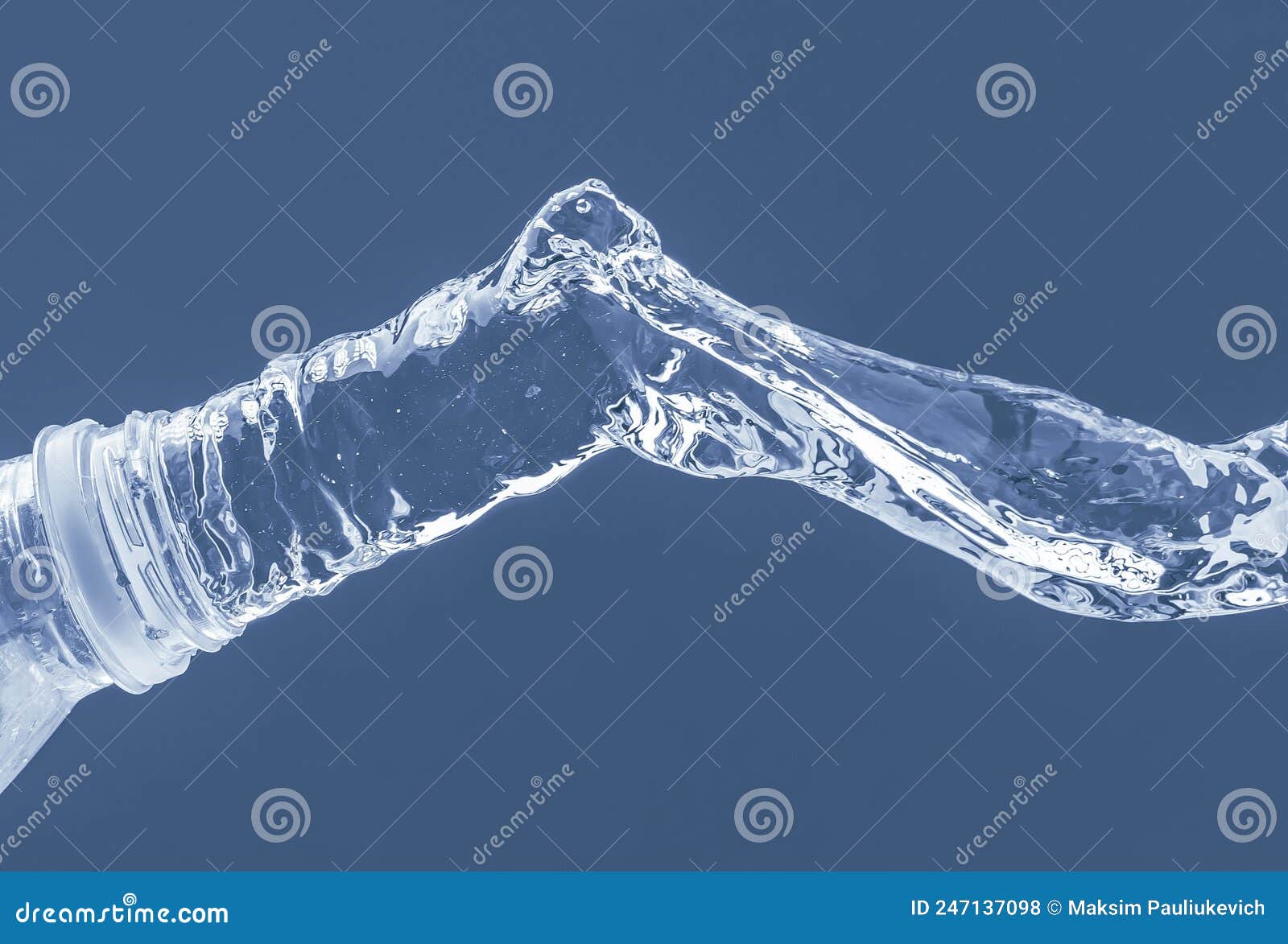 Splash of Water from a Bottle on a Blue Background. Stock Photo - Image ...