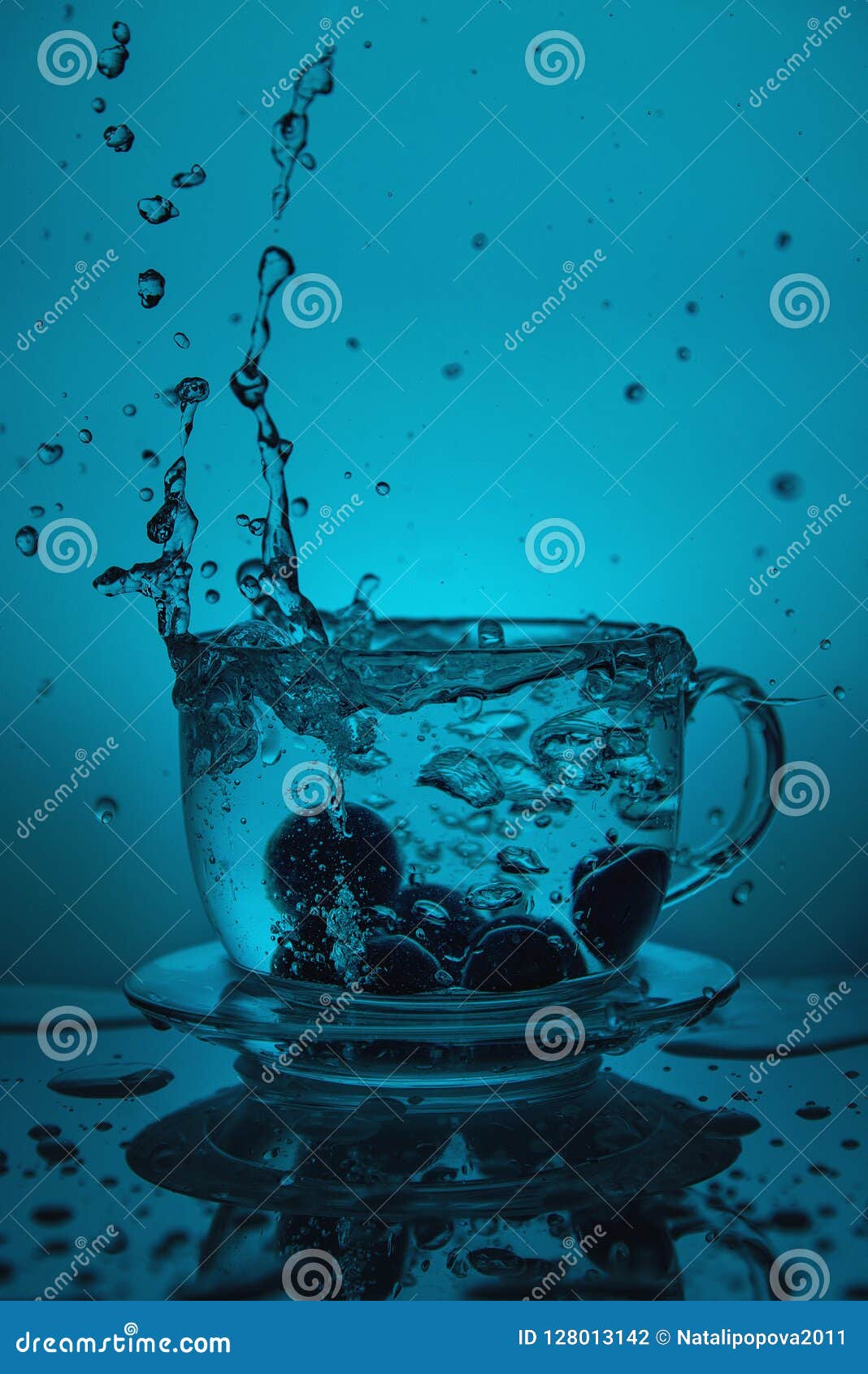 Splash of water in a cup stock photo. Image of liquid - 128013142
