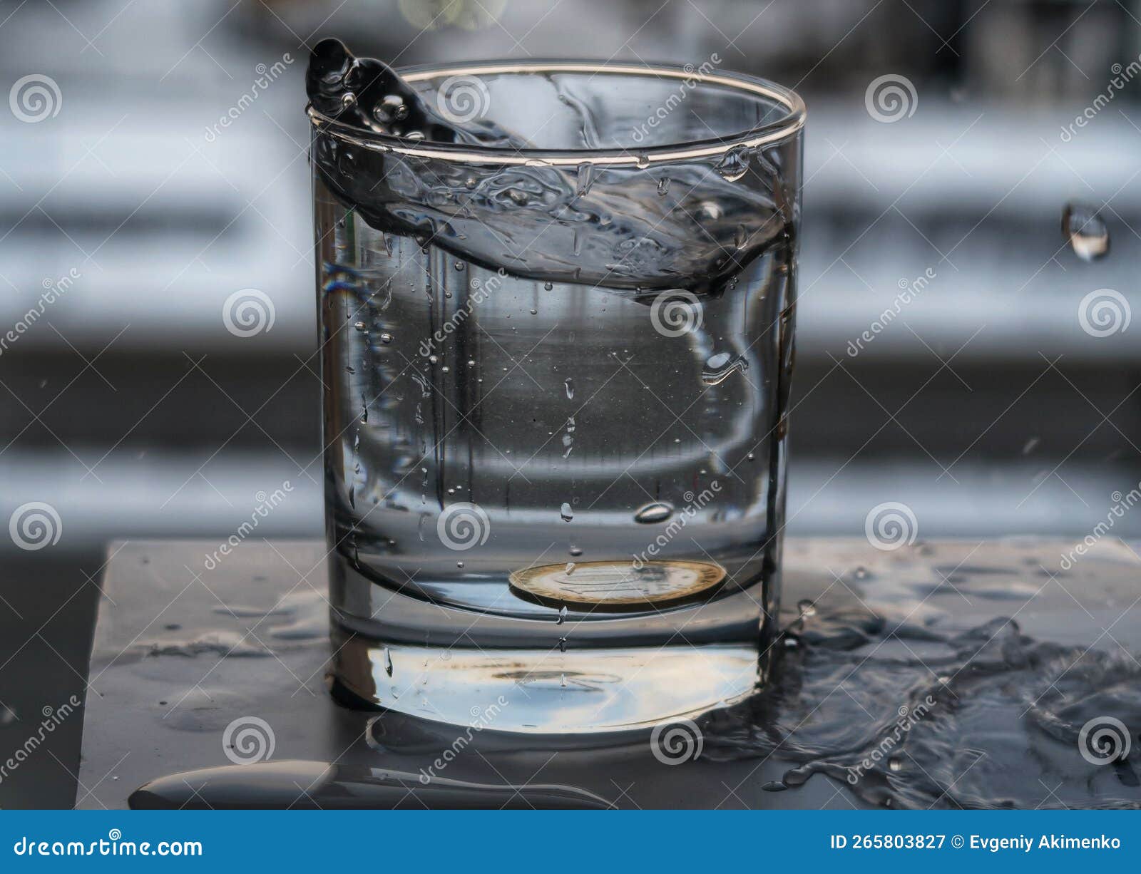 Splash of Water in a Glass from a Tossed Coin Stock Image - Image of ...