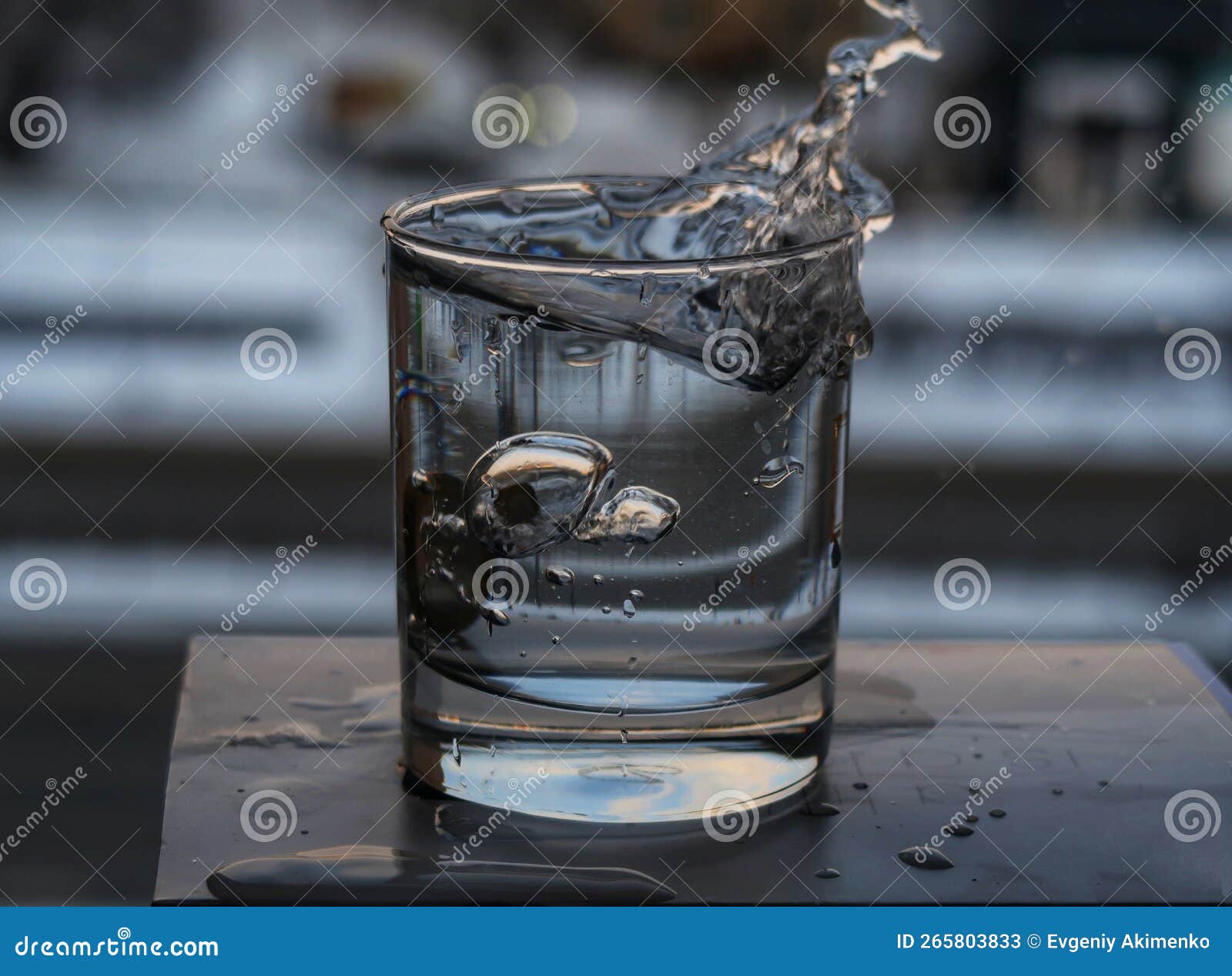 Splash of Water in a Glass from a Tossed Coin Stock Image - Image of ...