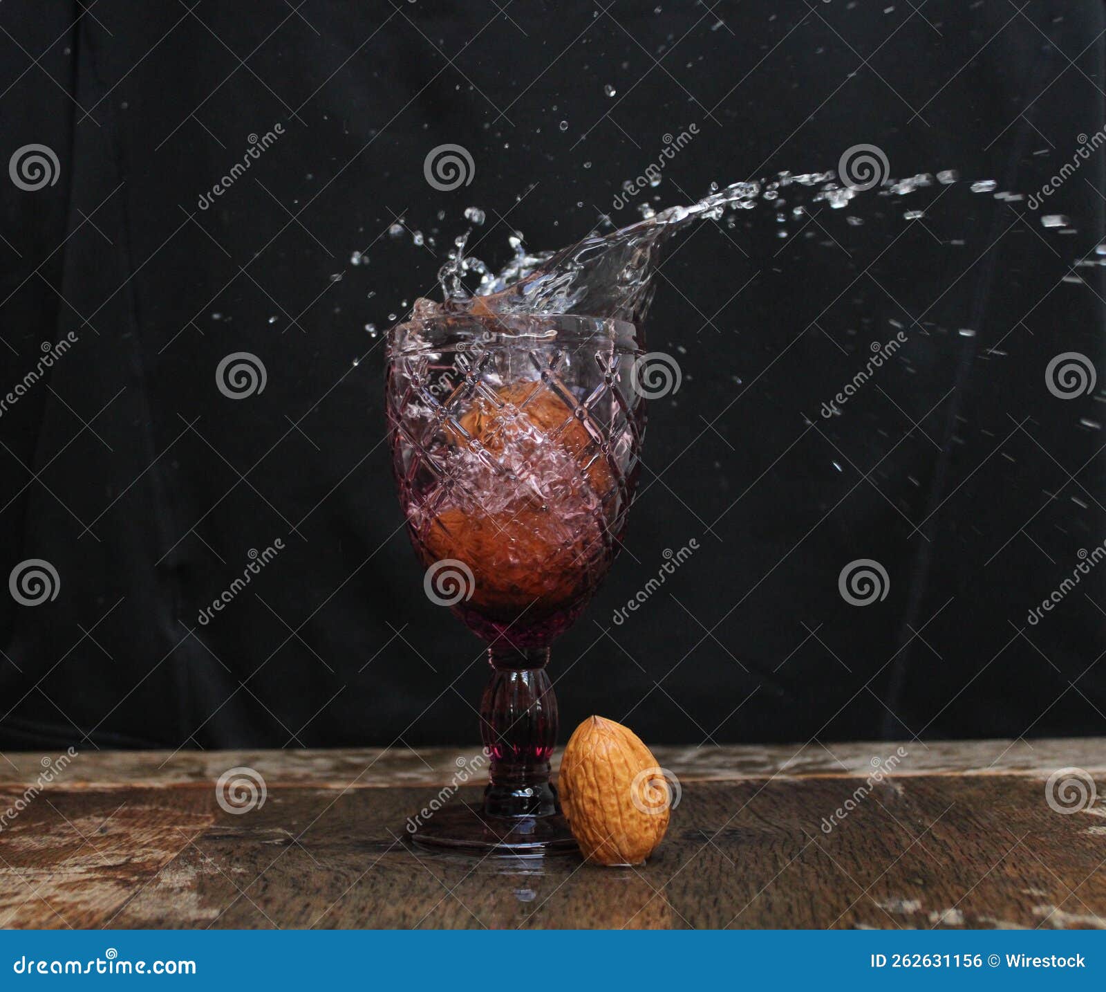 Splash of Water in a Glass with a Walnut Stock Photo - Image of closeup ...