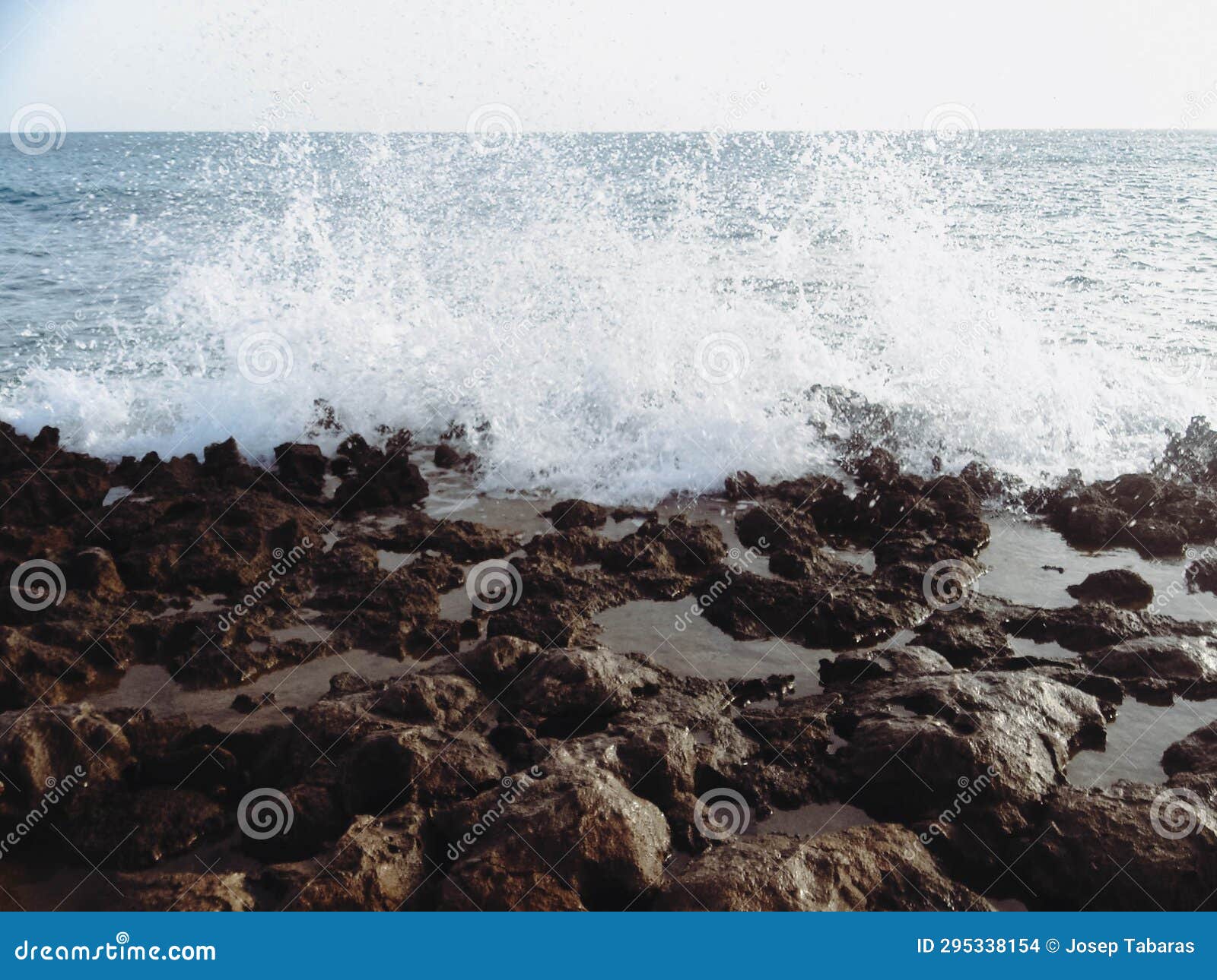 The Splash of Water when the Wave Breaks between the Rocks Stock Photo ...