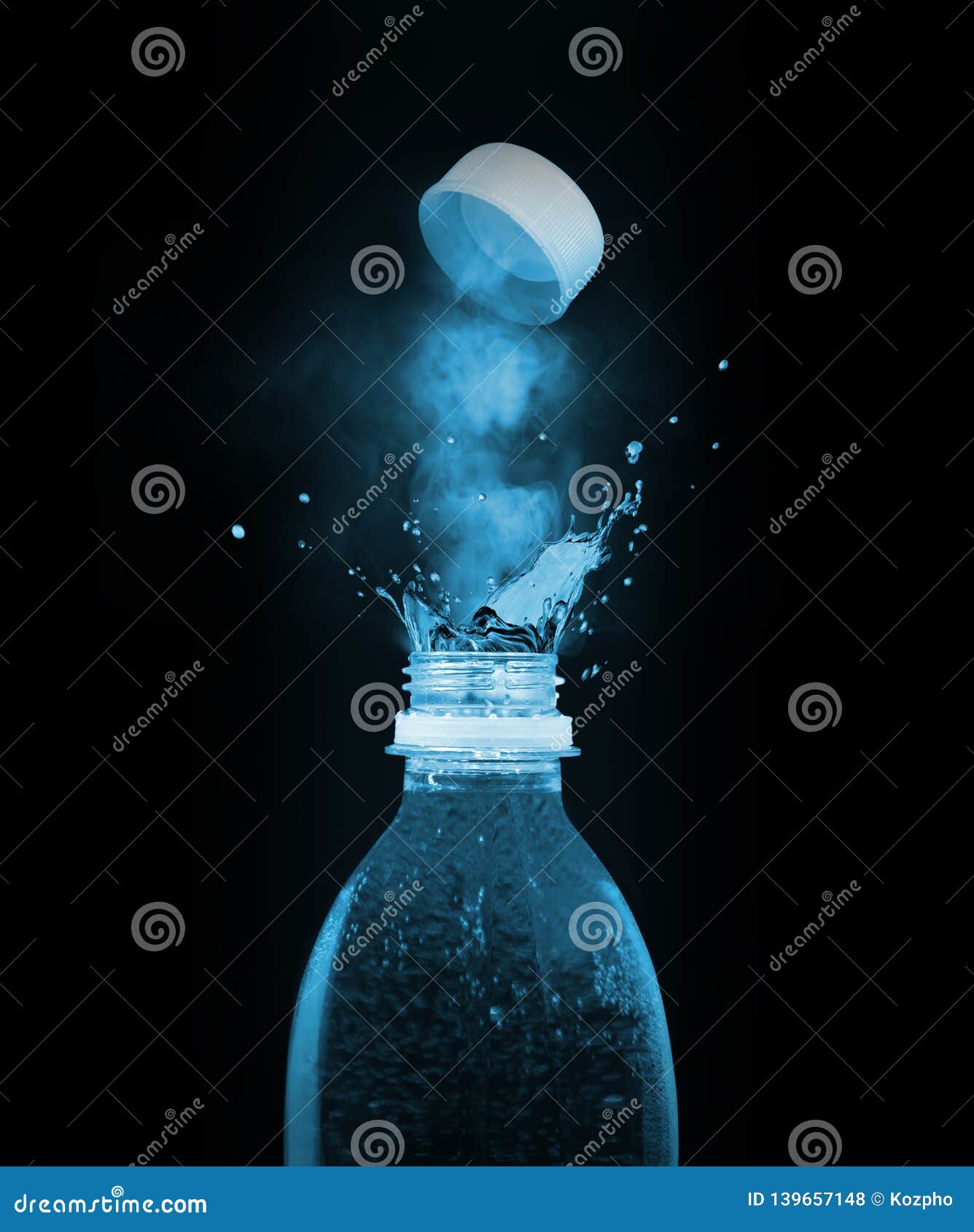 Splashes of Mineral Water Spill Out of the Bottle in the Dark Stock ...