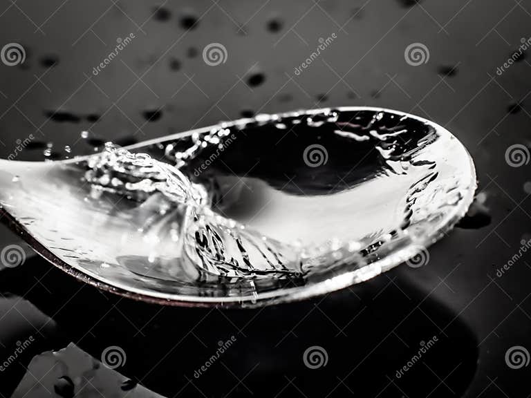Splashing a Drop of Water in a Teaspoon Stock Image - Image of spoon ...