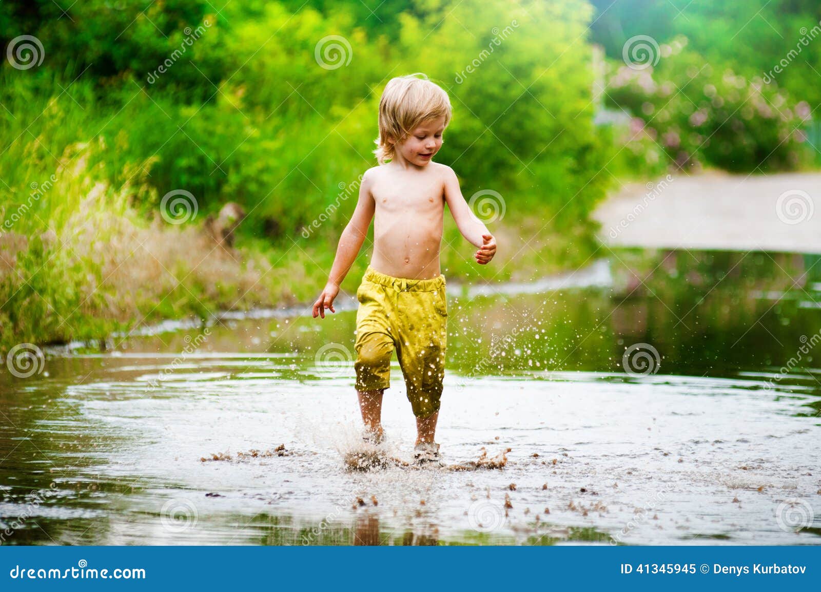 Splashing in a puddle stock image. Image of rainy, blond - 41345945
