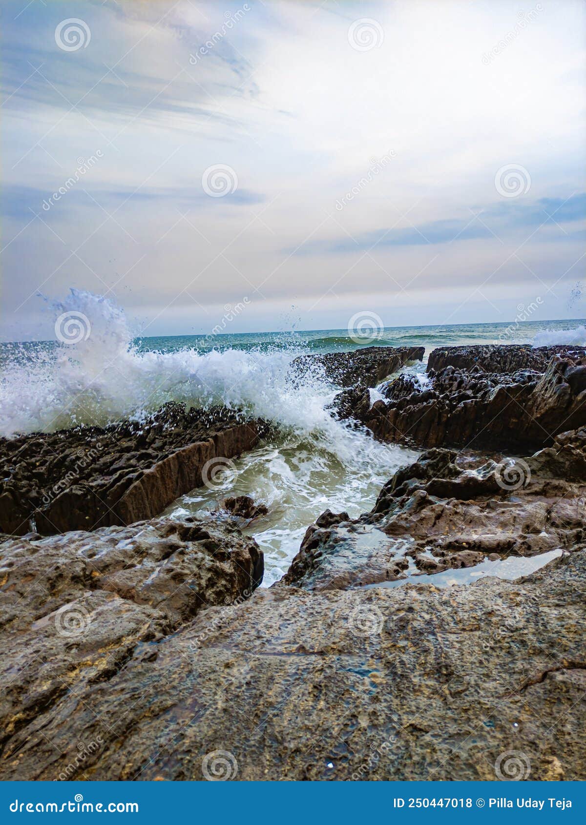 Splashing surf on rocks. stock photo. Image of sand - 250447018