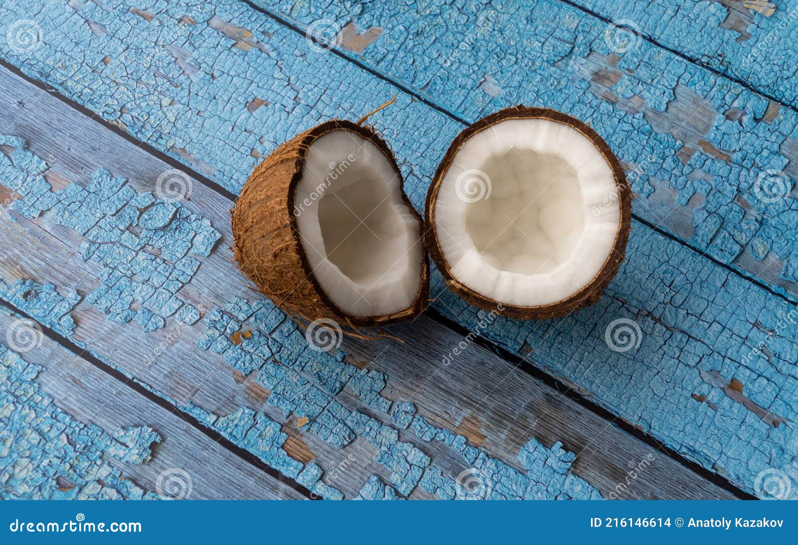 Split Coconut on Blue Wooden Planks. Coco, Ripe Palm Fruit Stock Photo ...