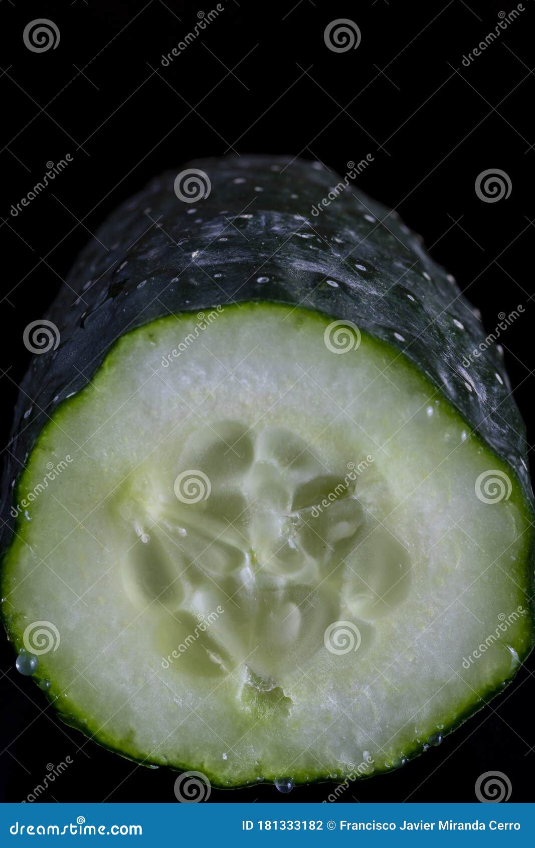 Split Cucumber Showing Its Inside And Releasing Its Juice Stock Photo ...