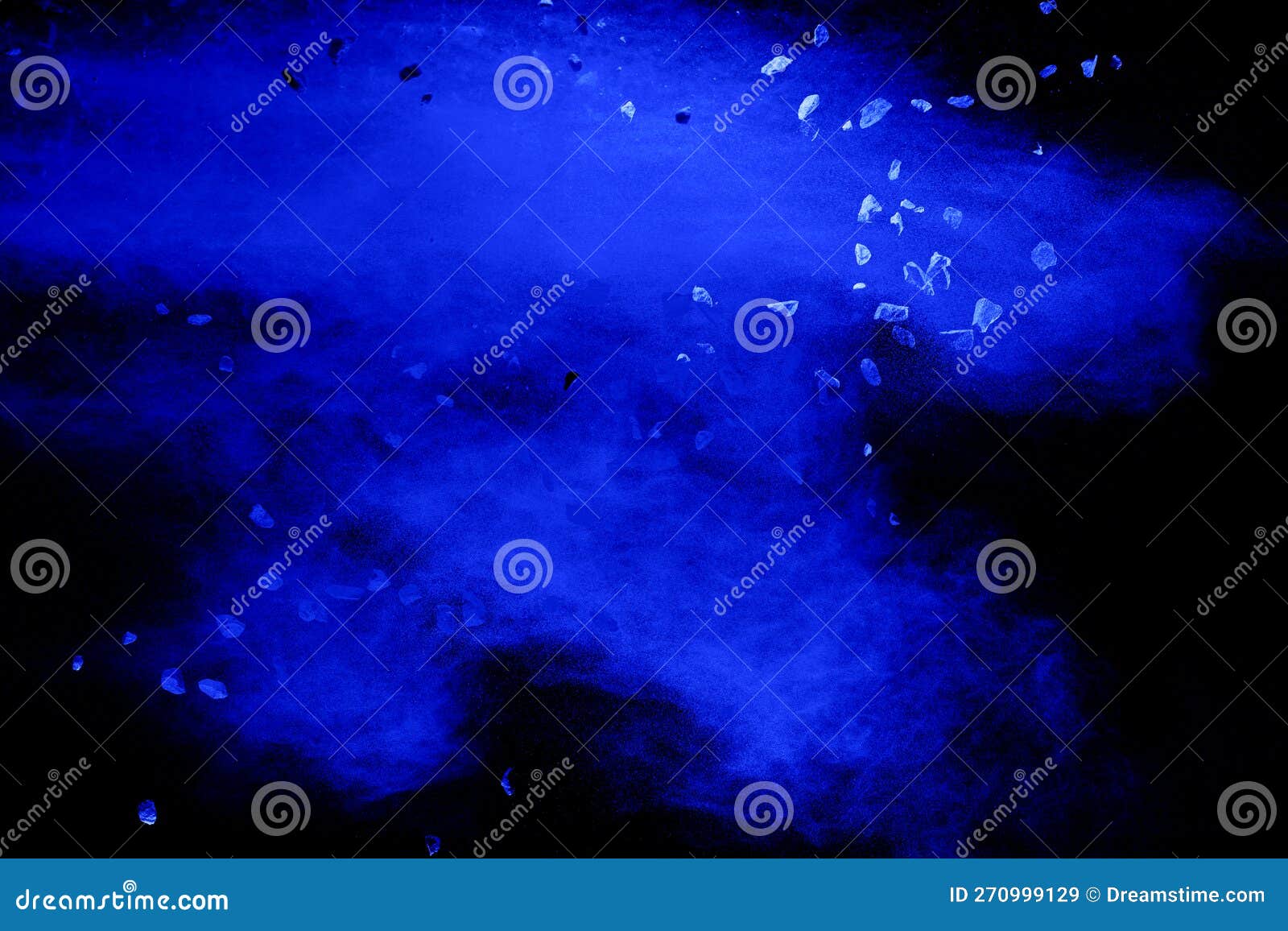Split Debris of Stone Exploding with Blue Powder Against Black ...