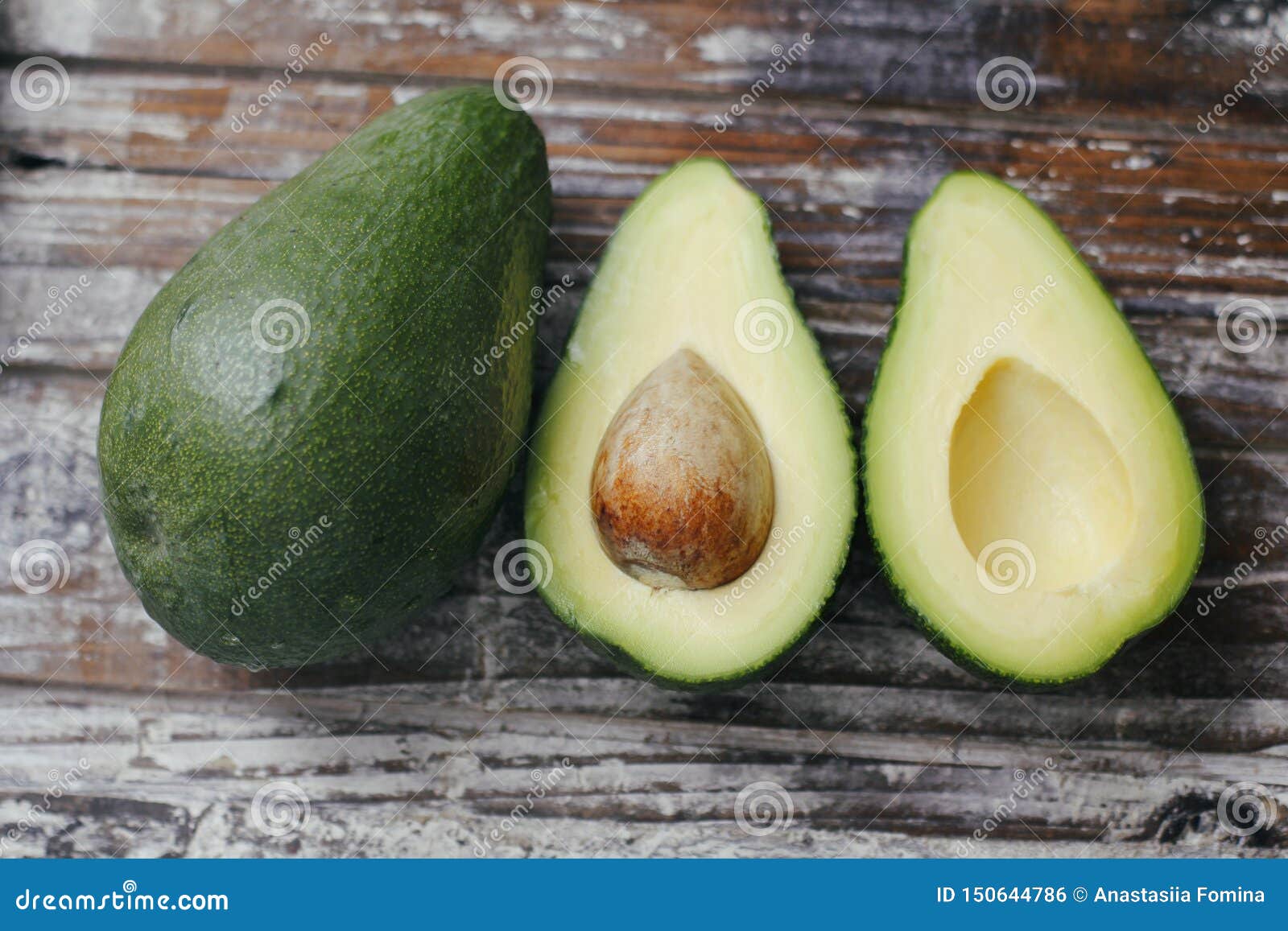 Split Fresh Raw Avocado with and without Pit. on Wooden Table. Stock ...