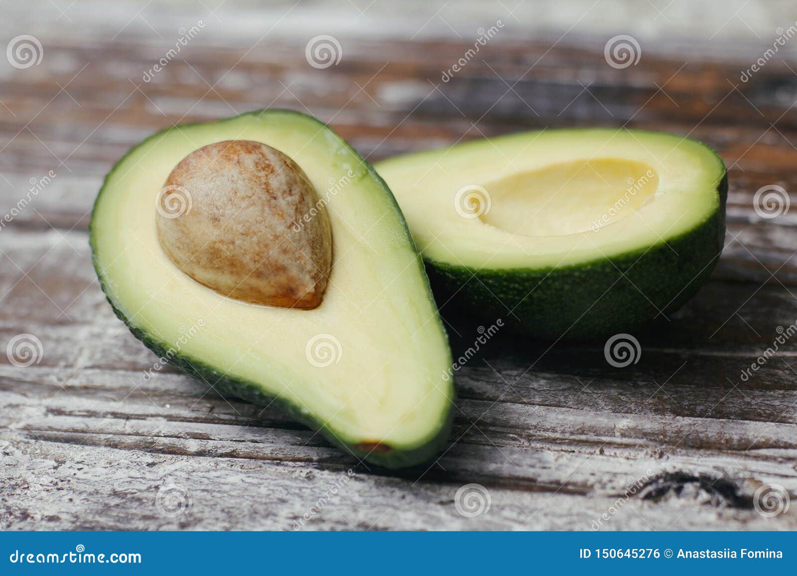 Split Fresh Raw Avocado with and without Pit. on Wooden Table. Stock ...