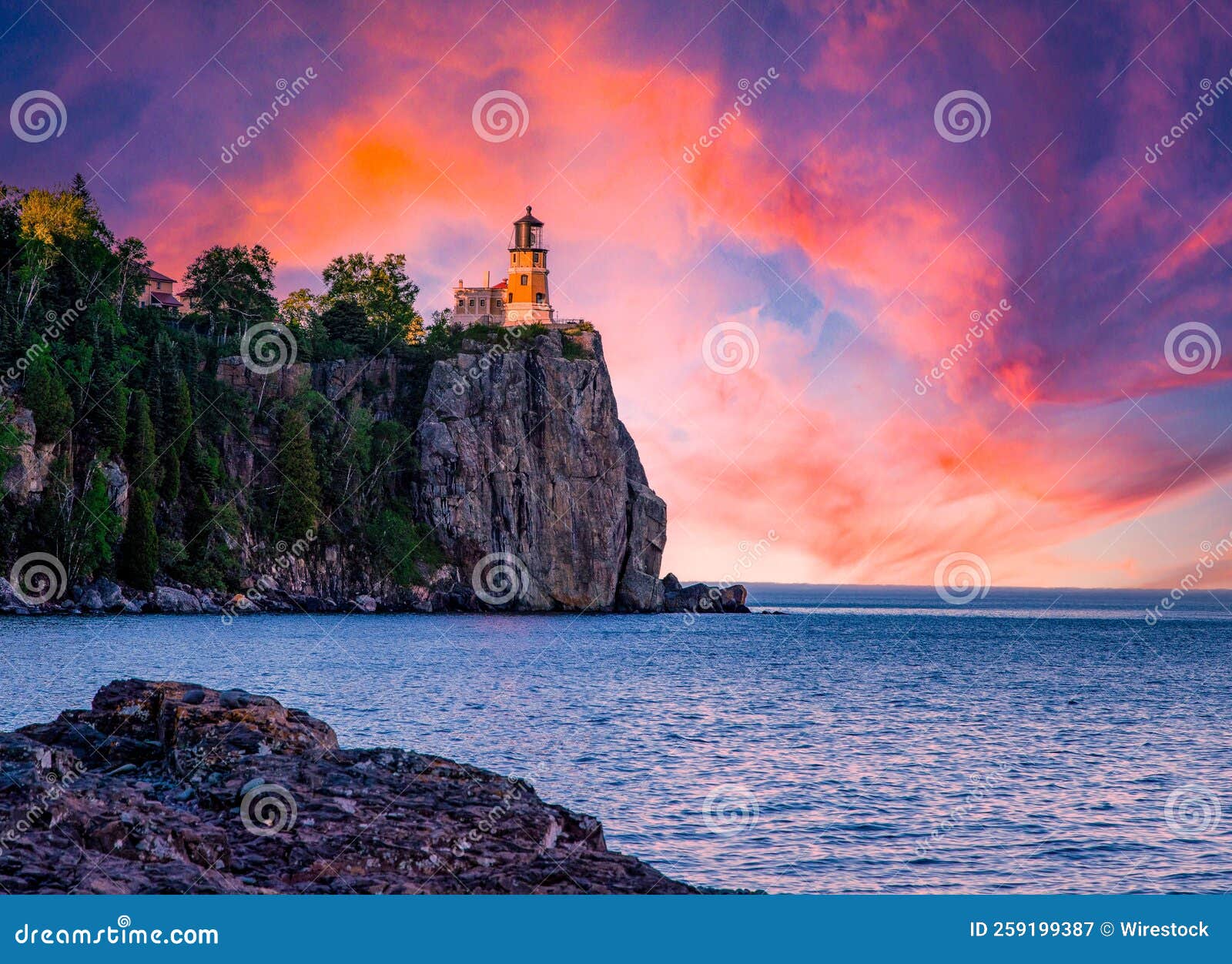 Split Rock Lighthouse at the Edge of a Waterside Cliff Under the Orange ...