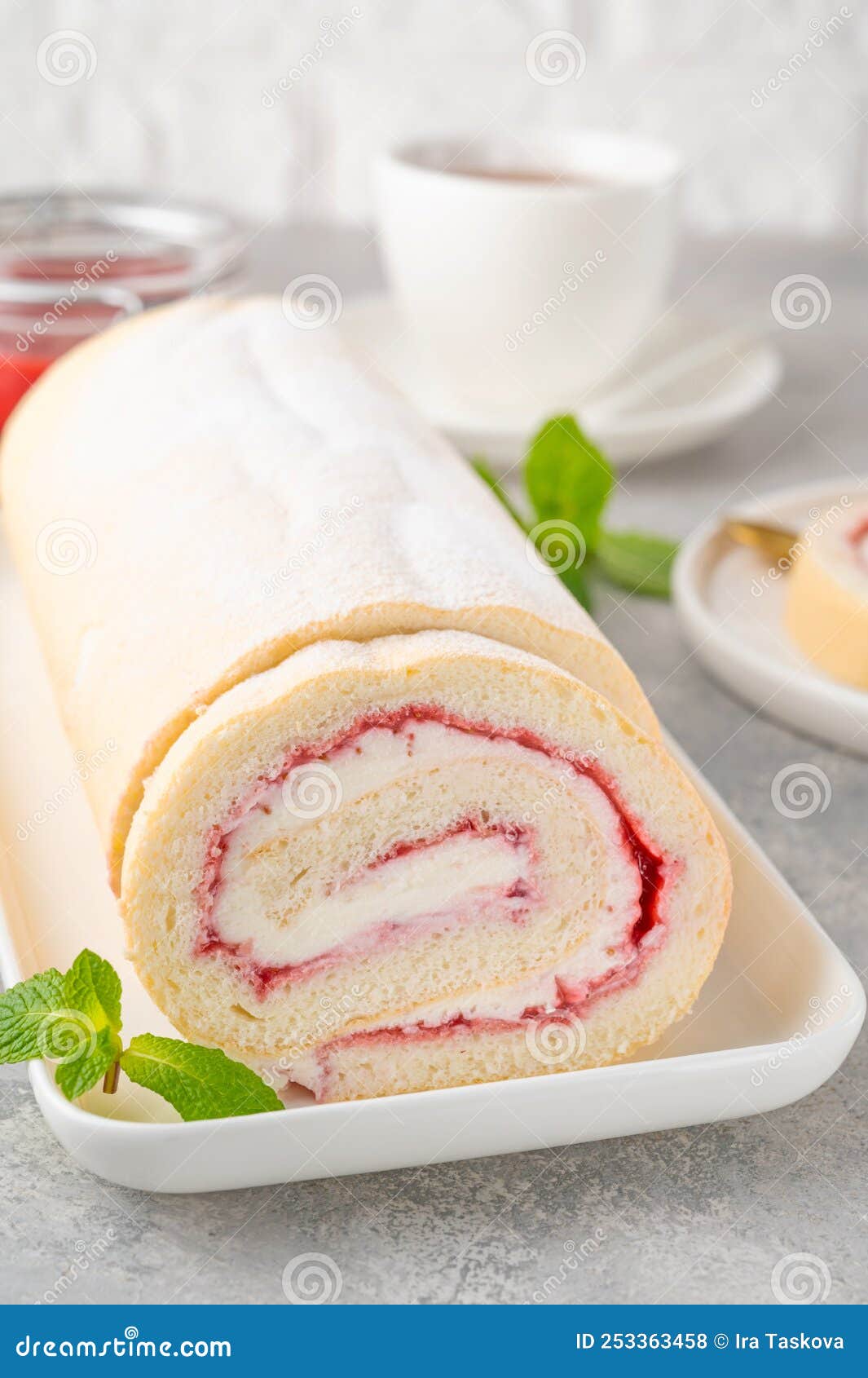 Sponge Cake Roll with Strawberry Jam and Cream on a White Plate on a ...