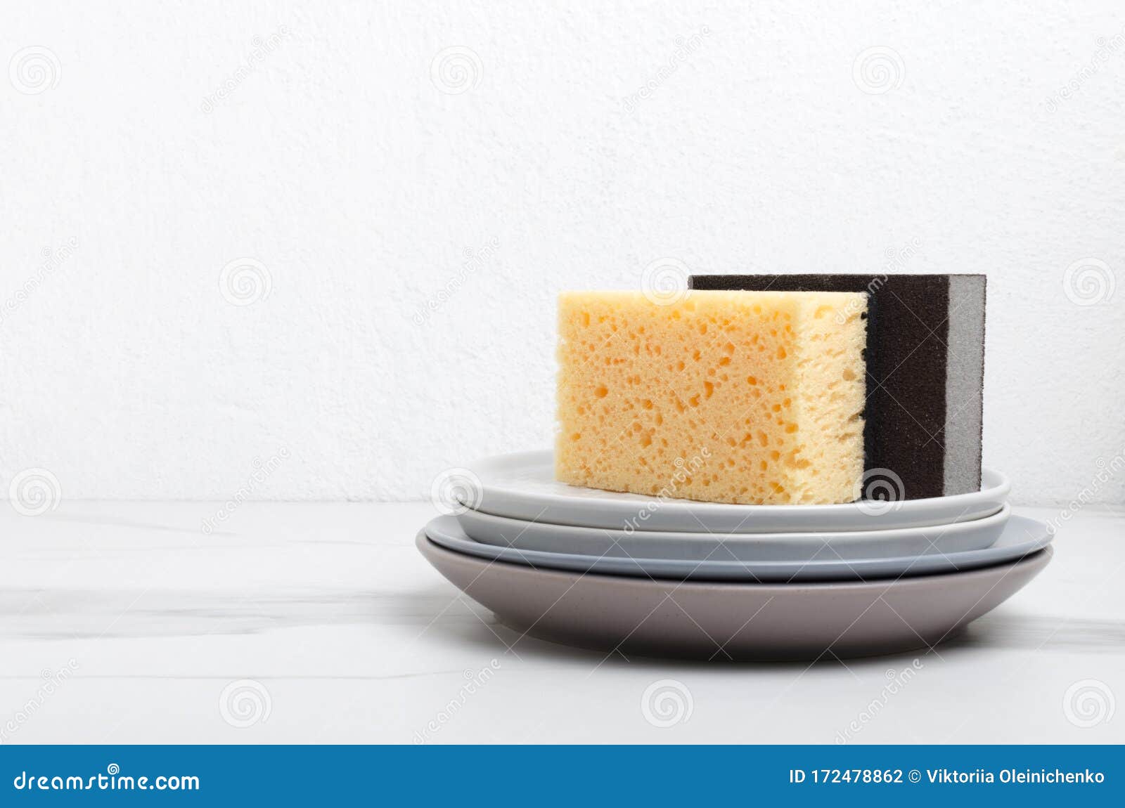 Sponge and Scrubber on the Stack of Clean Dry Plates, Kitchen Table ...