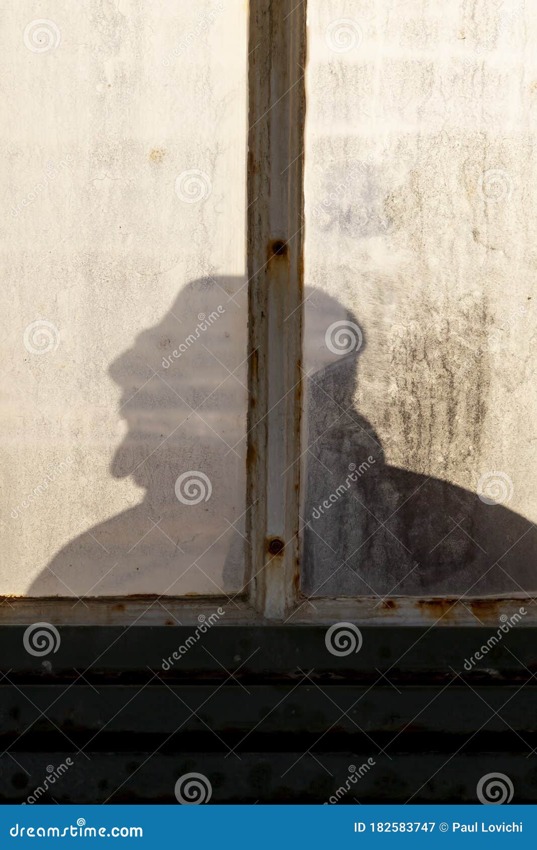 Spooky Shadow of Man at Bus Stop Stock Image - Image of shadow, sunset ...