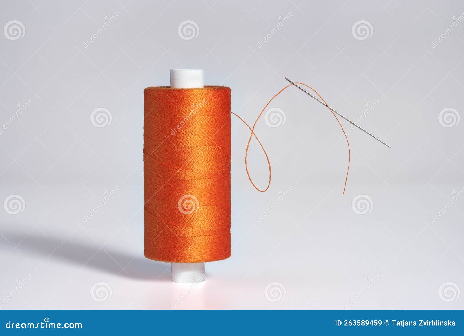Spool of Orange Threads with a Needle Levitate on White Background ...
