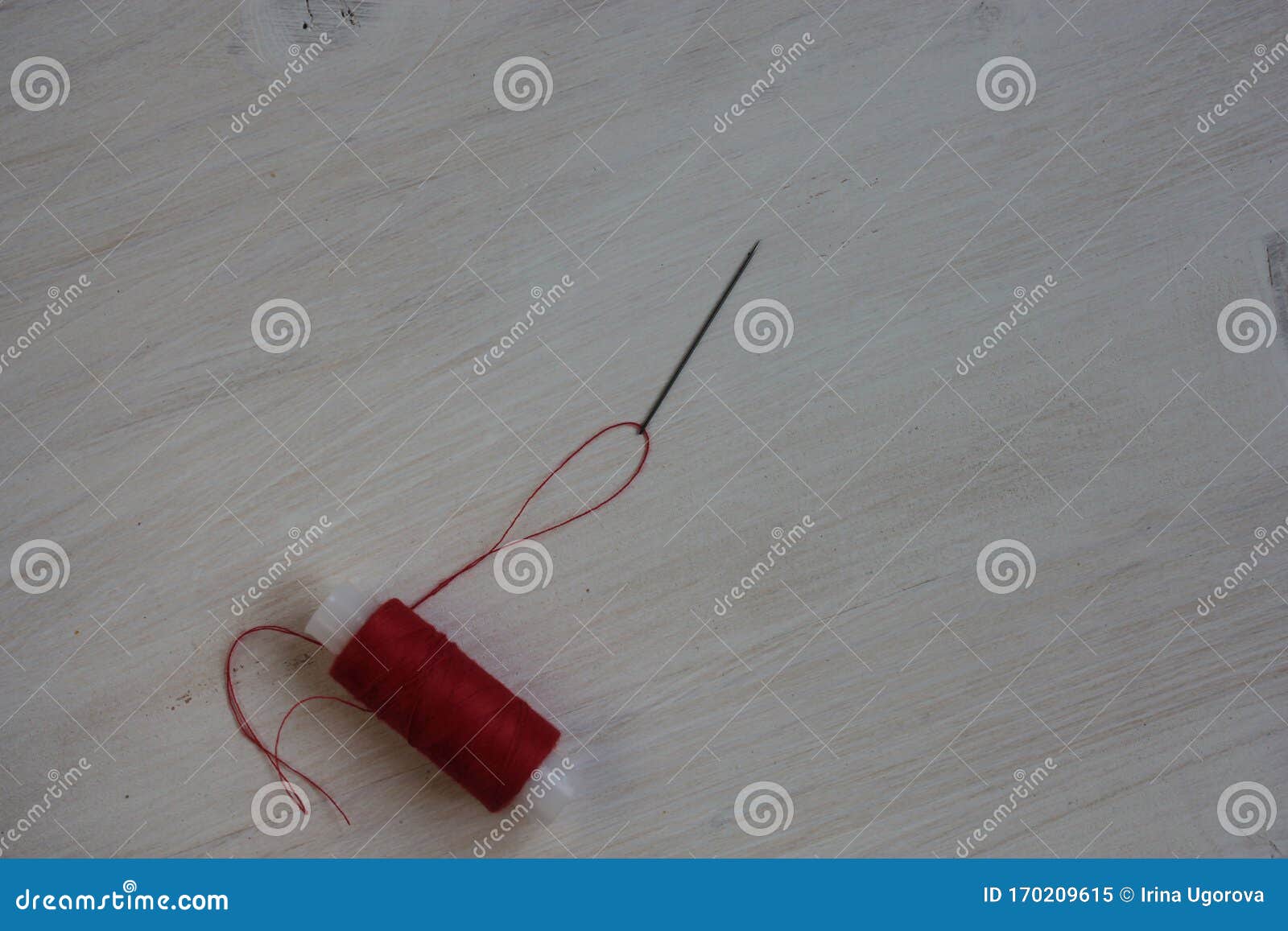 A Spool of Red Thread and a Needle with Thread. Stock Image - Image of ...
