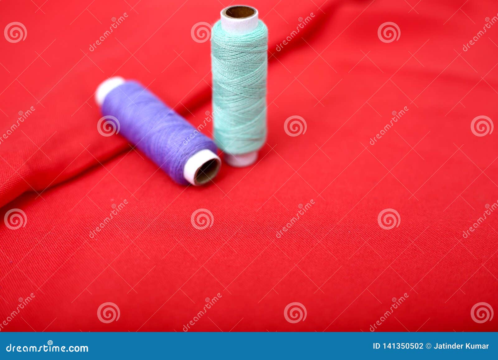 Spool of Sewing Thread on the Red Cloth Stock Photo - Image of ...