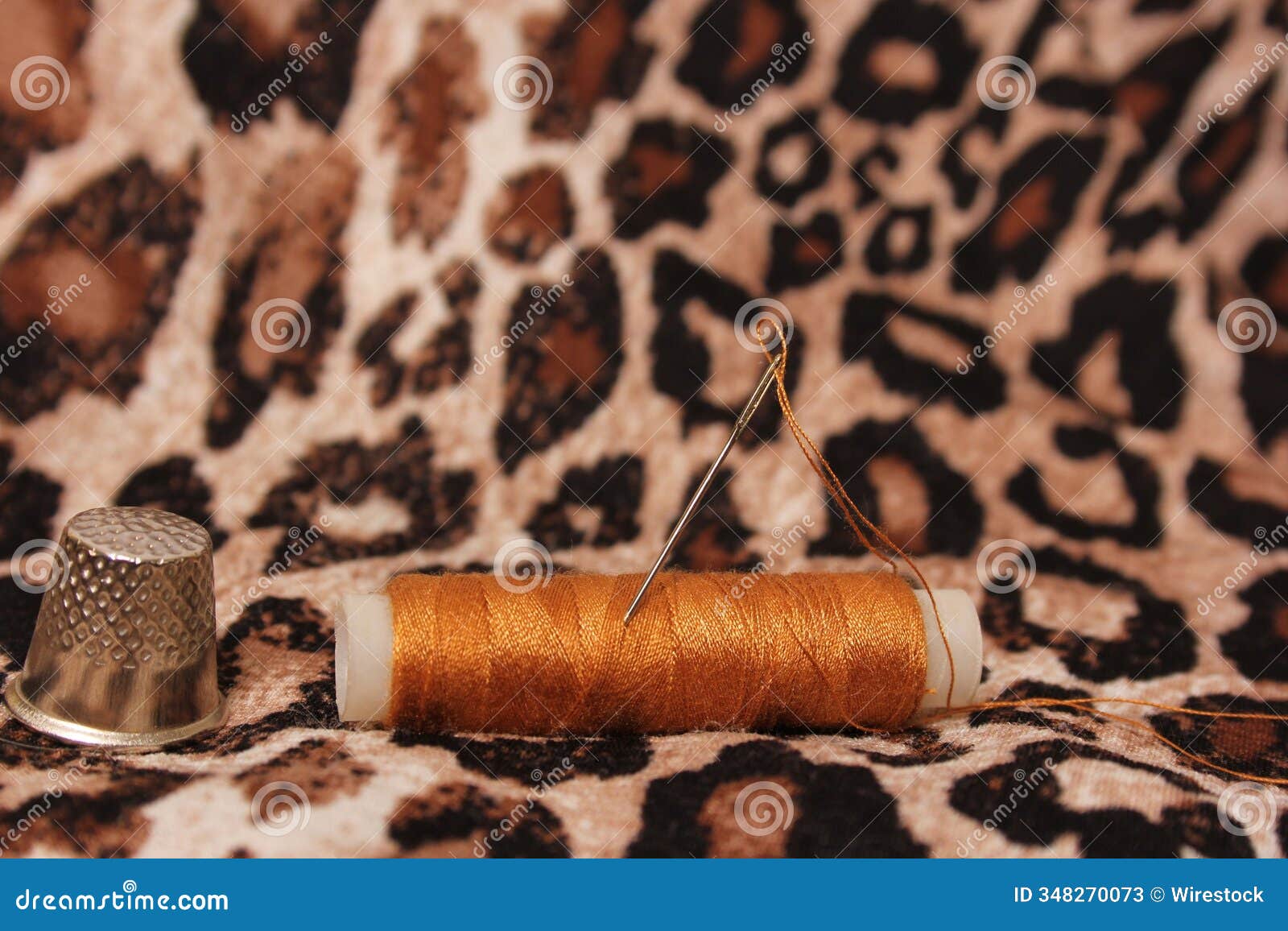 Spool of Tan Thread on Leopard Print Fabric Stock Image - Image of ...