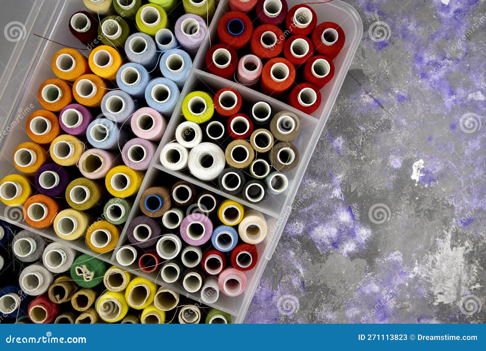 Spools of Bright Colored Threads in a Box on an Abstract Background ...